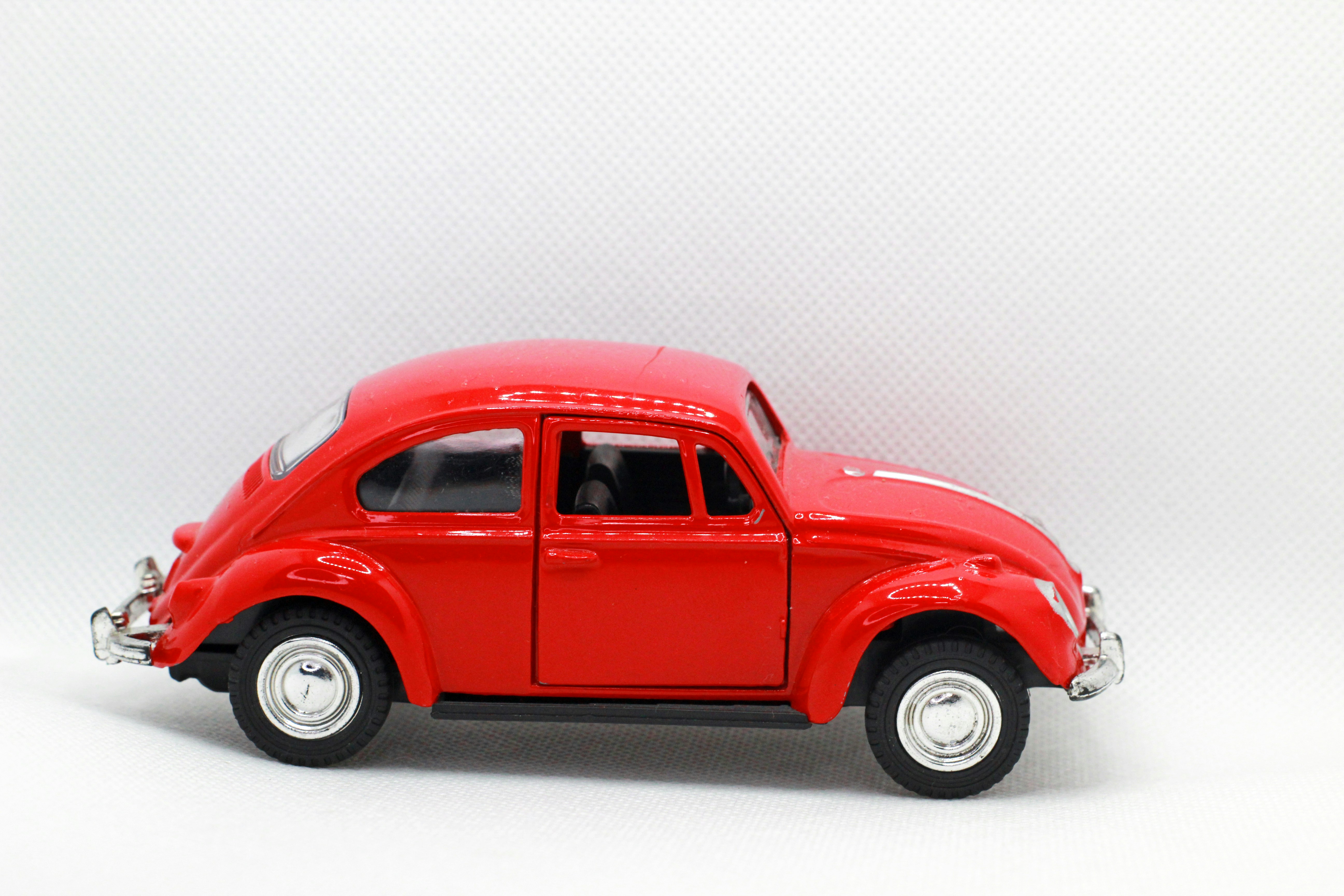 A red toy car on a white background photo – Free Car Image on Unsplash