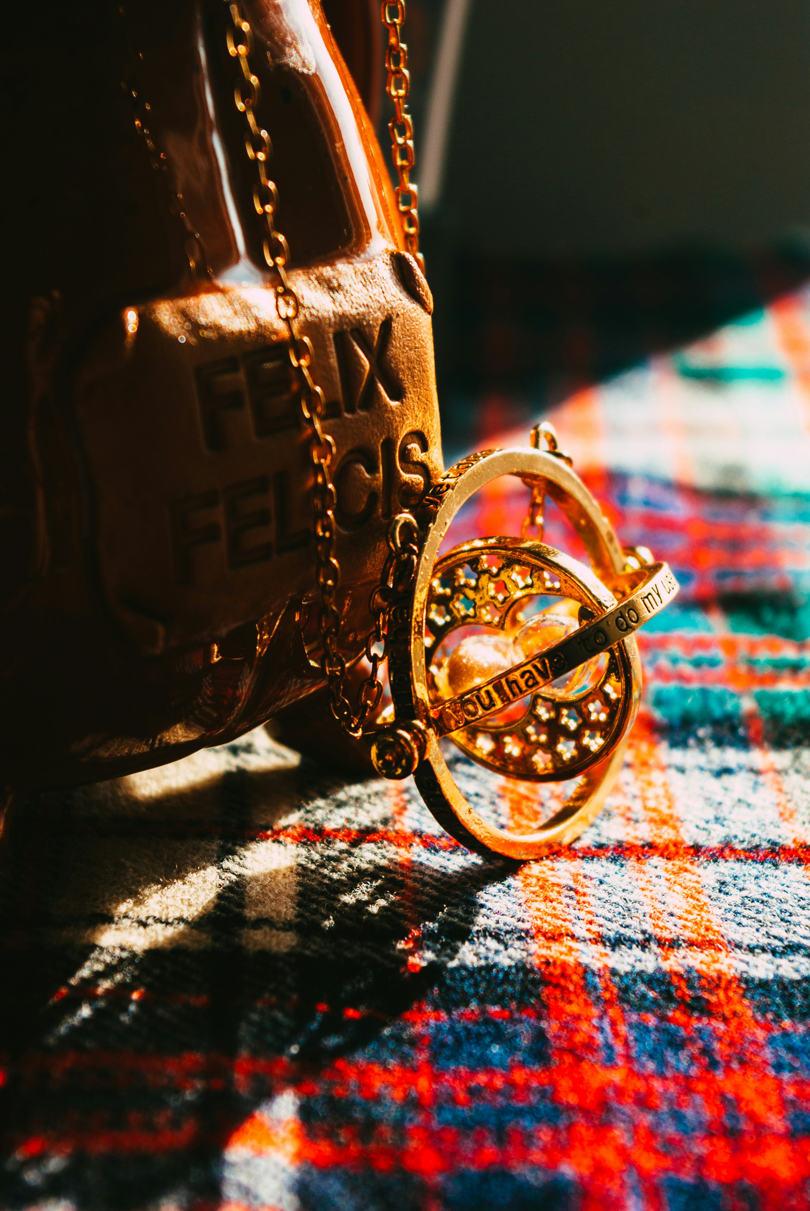 Sunlit Keepsake: A Golden Necklace Embraced by a Vintage Bottle
