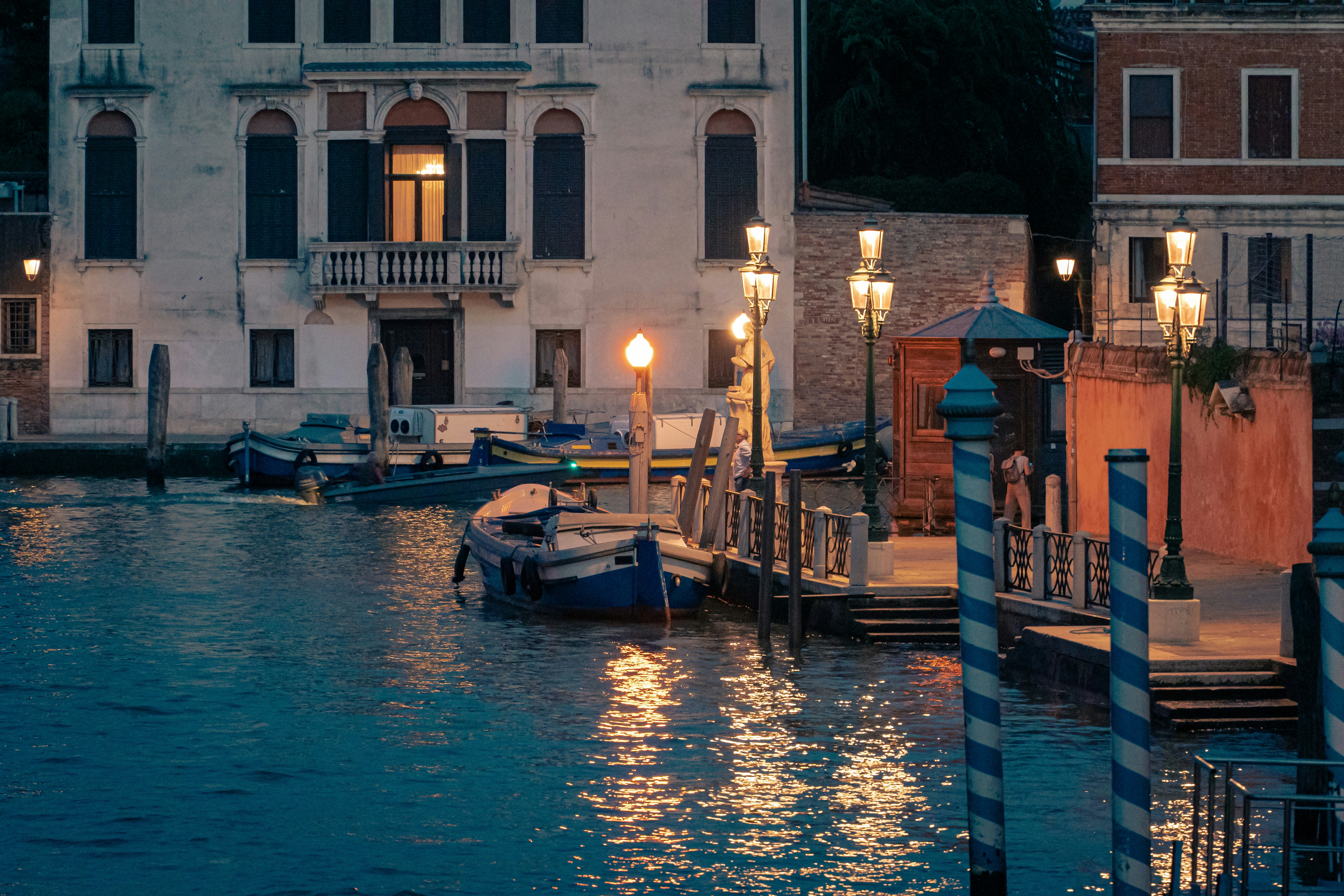 Dusk on the Venetian Canal: Lanterns, Boats, and Reflections