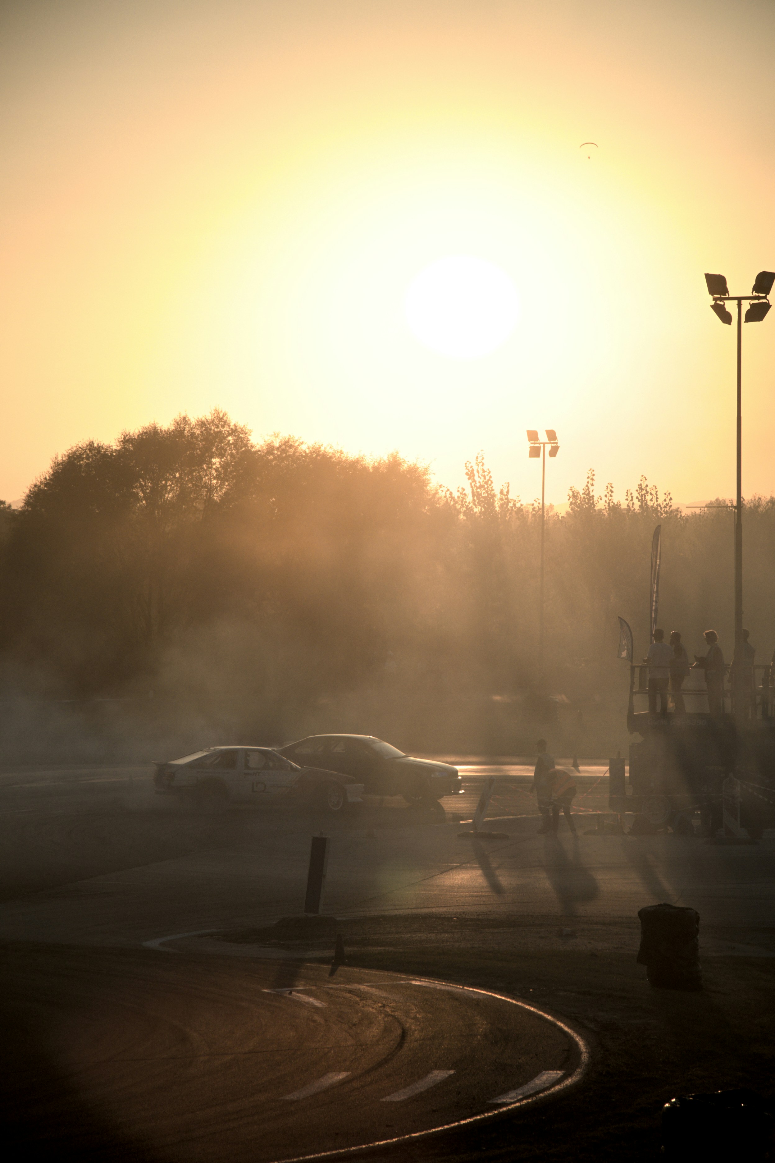 Goldglow on the Dusk Circuit: Silhouettes and Smoke Over a Sunset Race Track