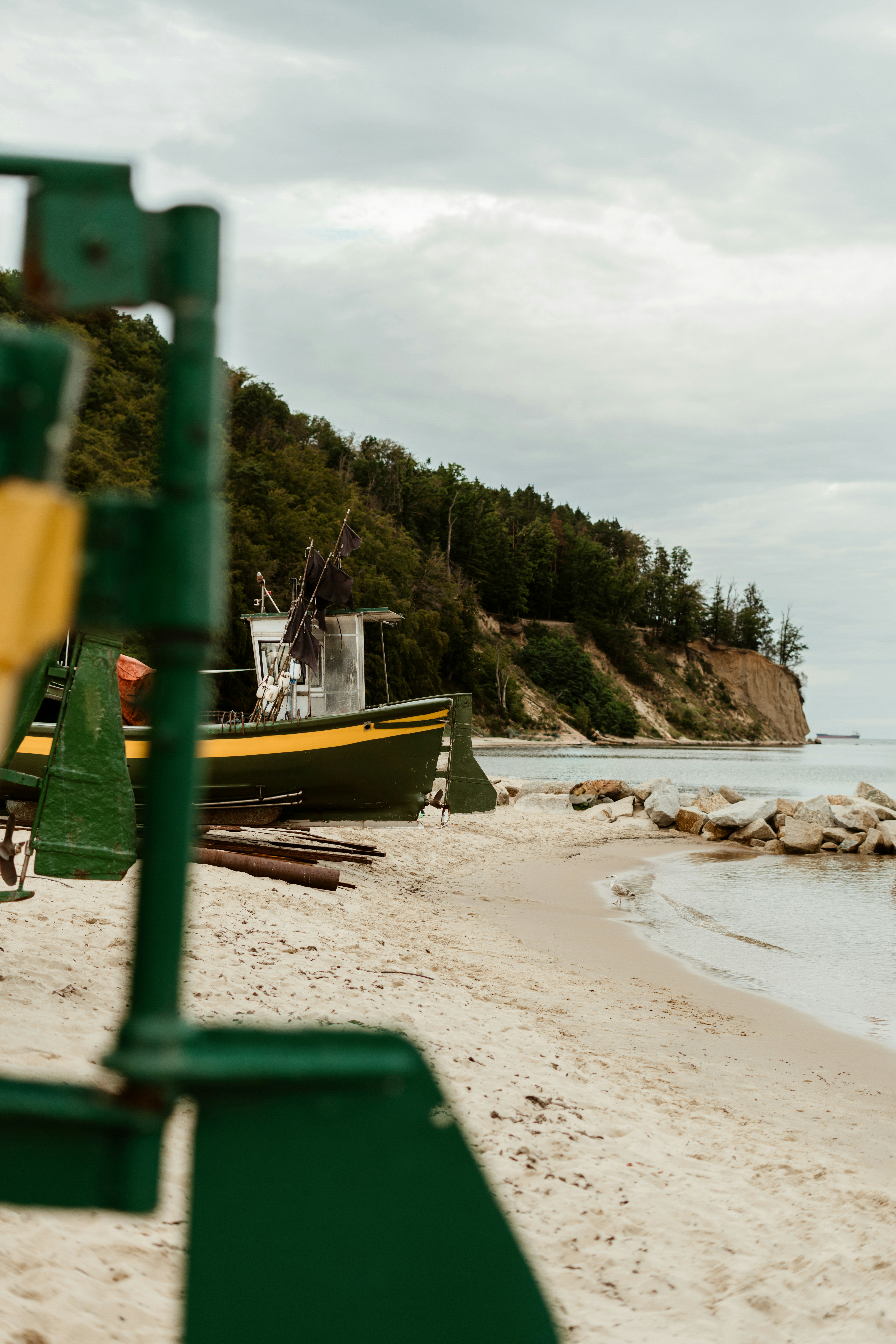 Green Frame, Yellow-Striped Vessel, and a Quiet Seaside in Soft Light