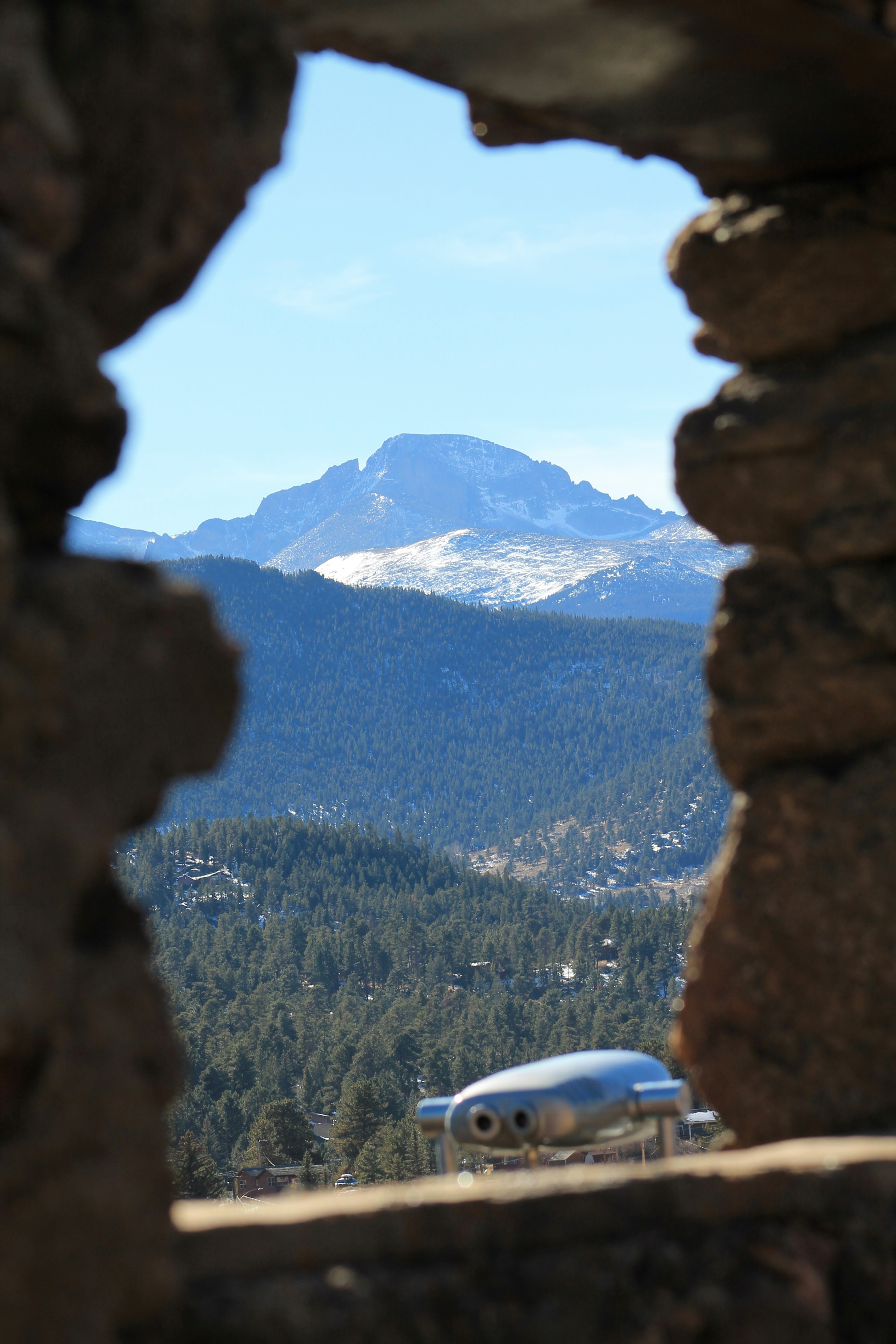 Snow-capped peak framed by rugged arch
