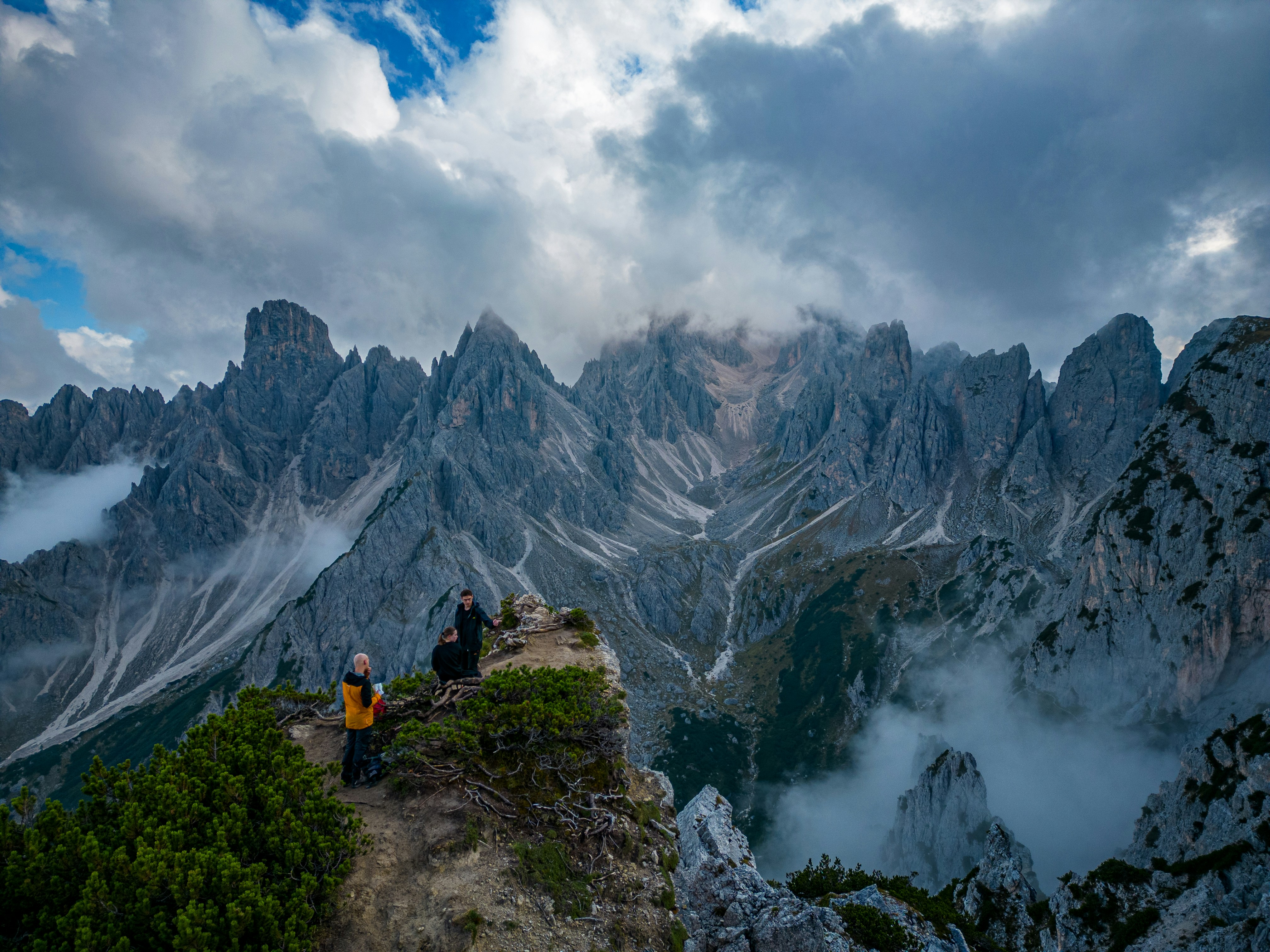 Ridge of Echoes: Climbers at the Cloud-Wreathed Crest