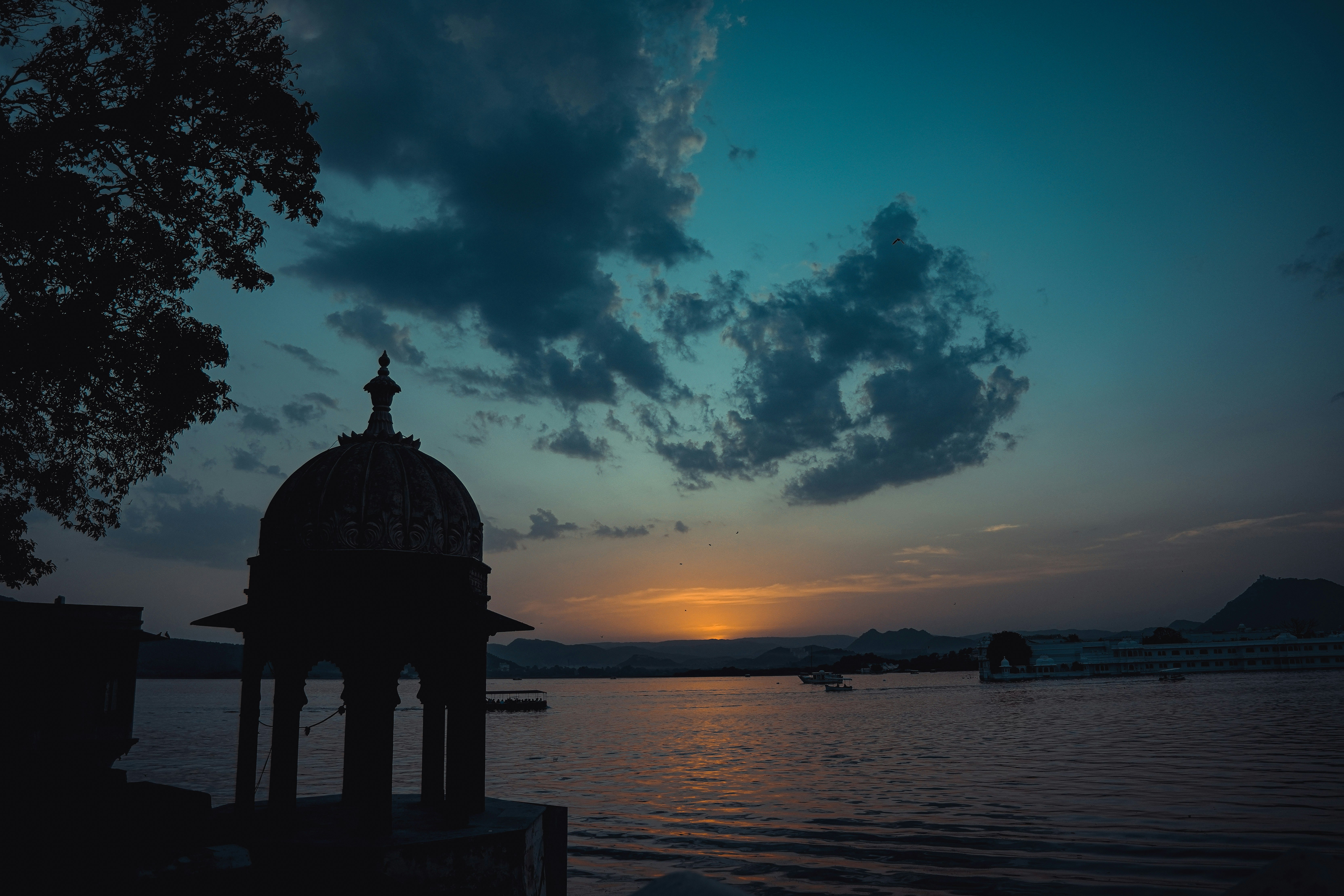 Dusk Over the Lake: Silhouetted Domed Pavilion Framed by a Golden Horizon