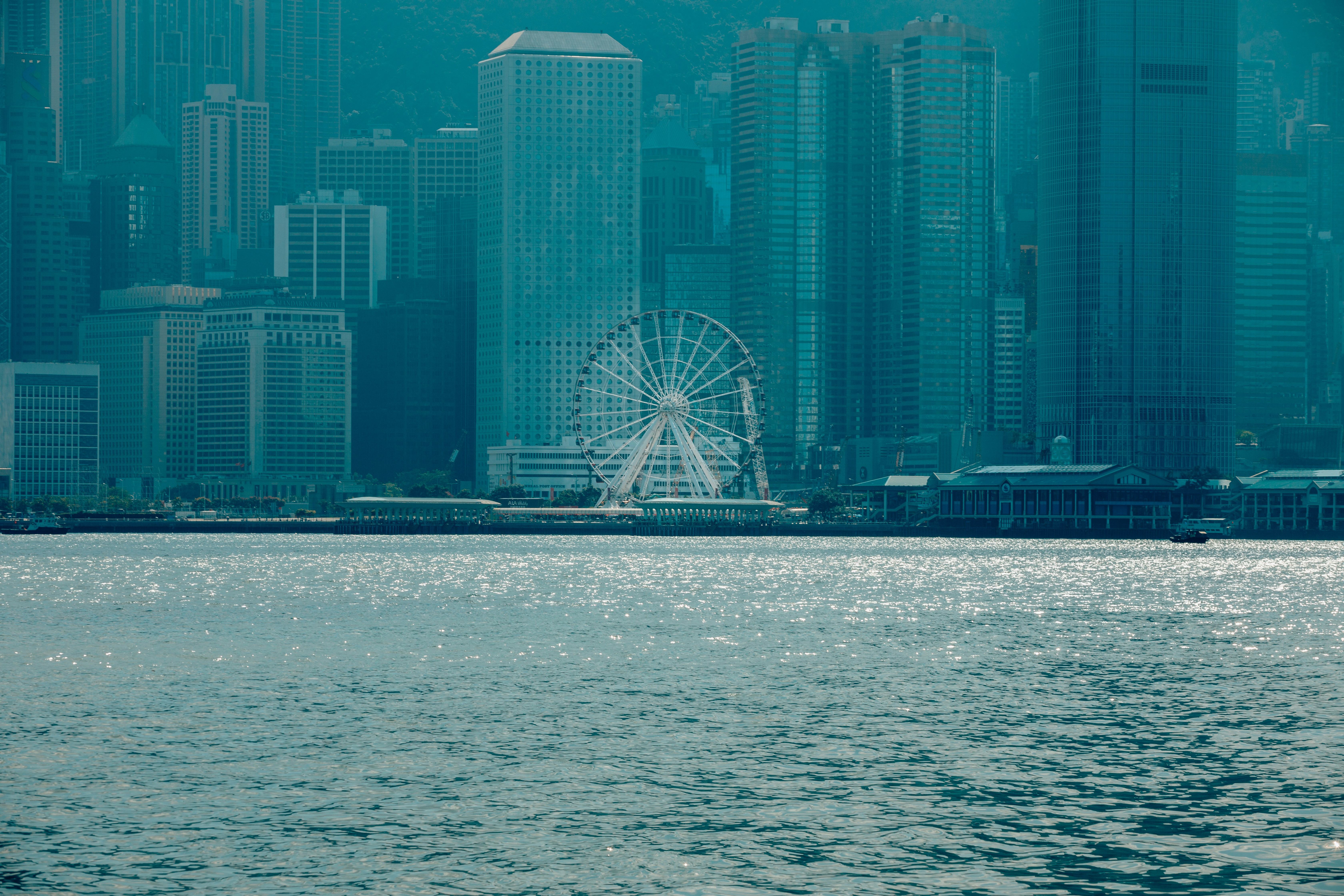 Teal Harbor Vista: Ferris Wheel Framing Hong Kong’s Waterfront