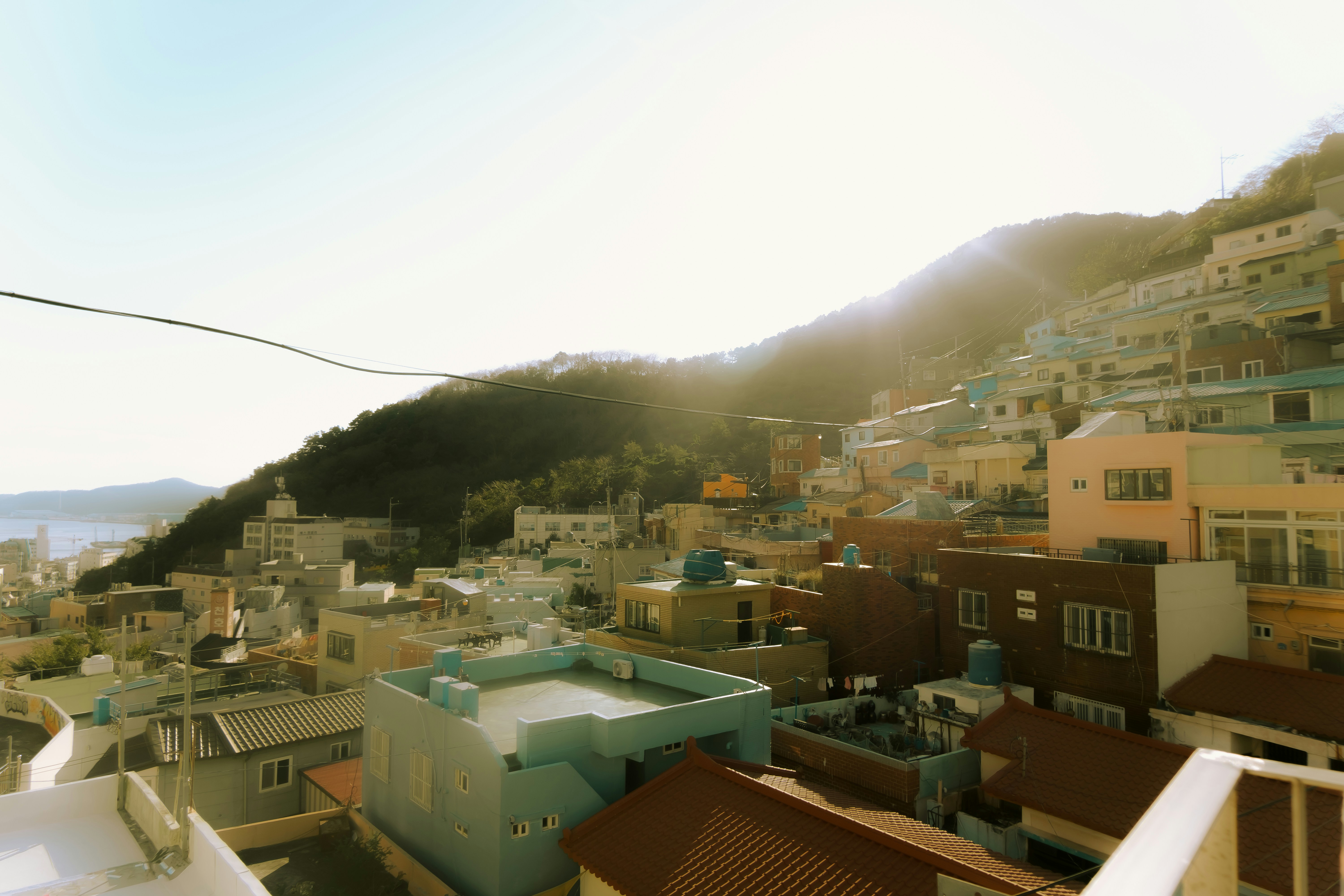 Sunlit hillside village over an sea-salted cityscape