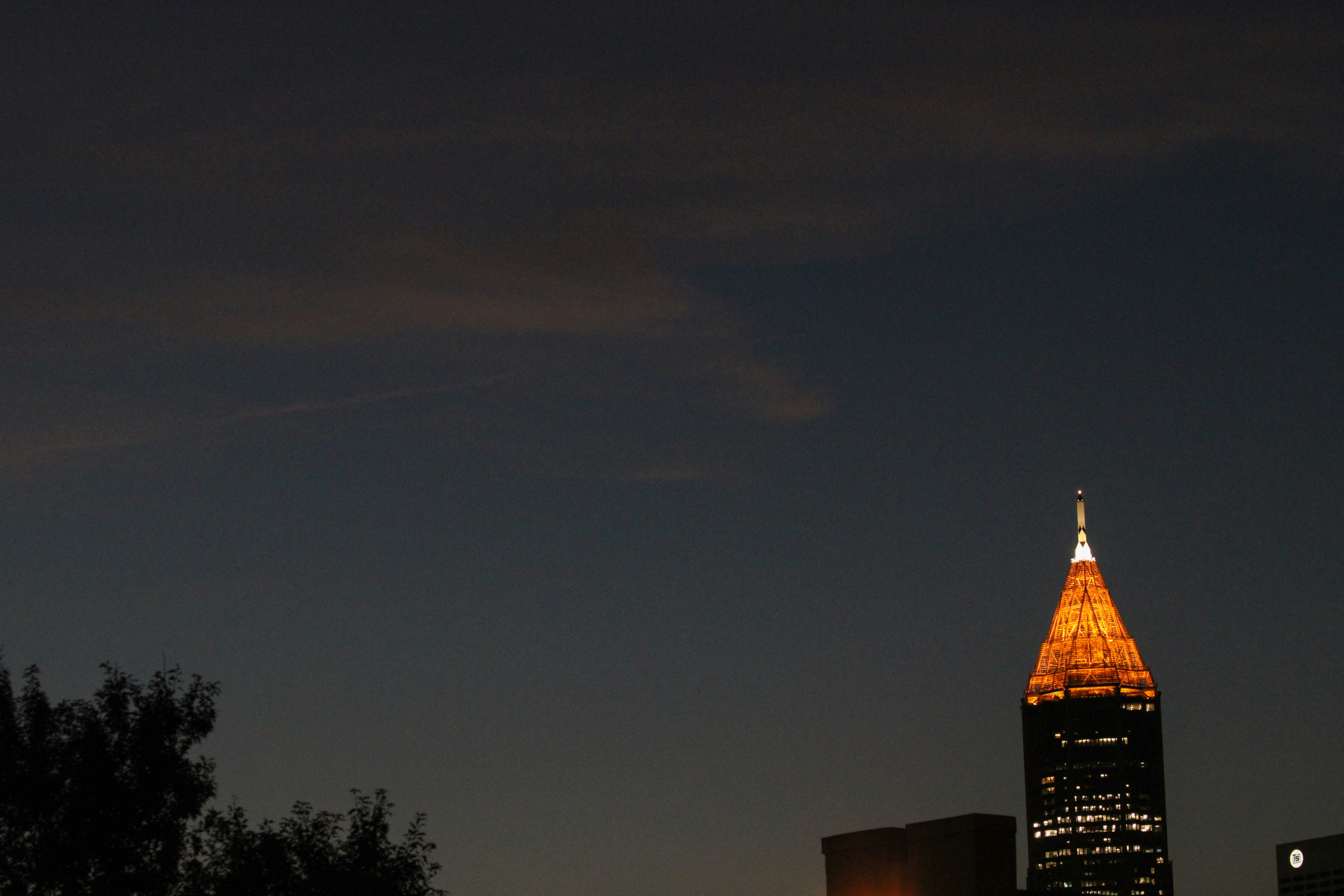 A very tall building lit up at night photo – Free Jackson street bridge ...