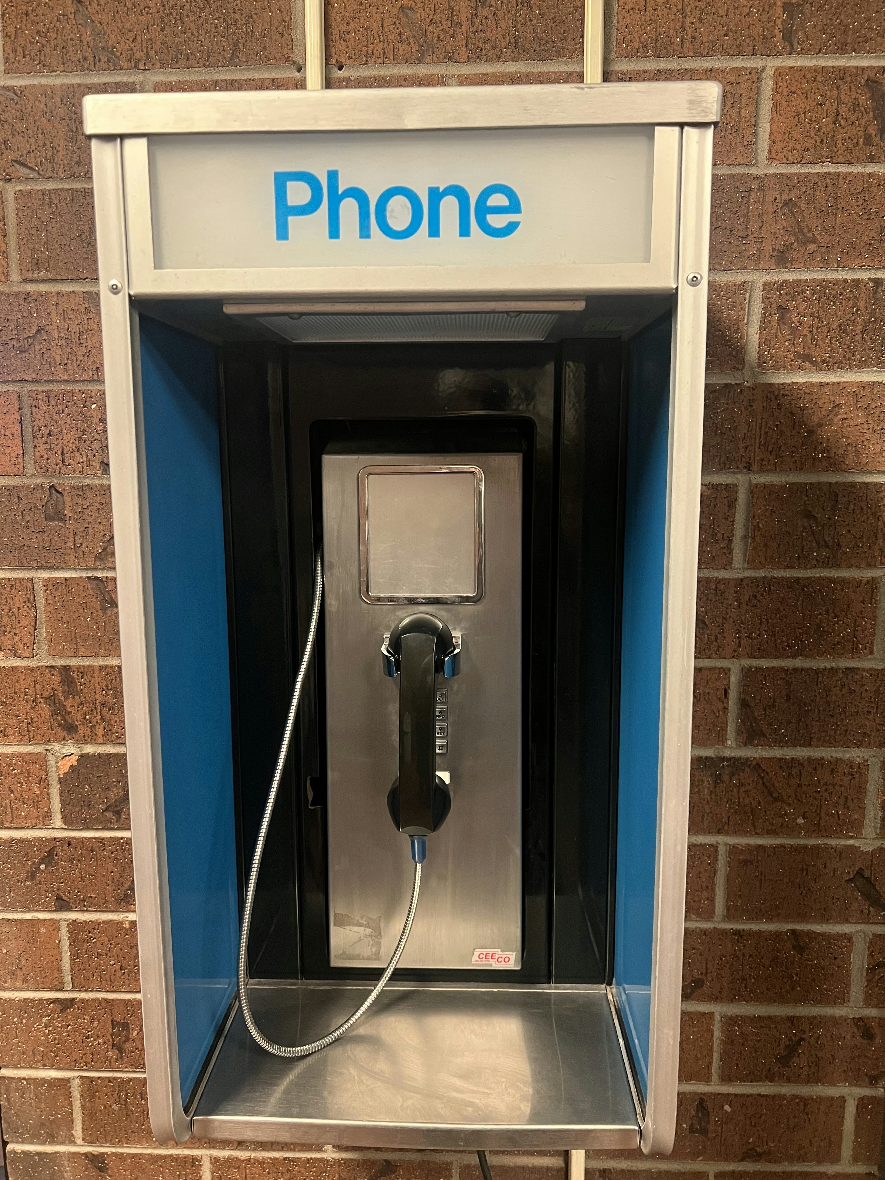 A phone booth with a phone hooked up to it photo – Free Electrical ...