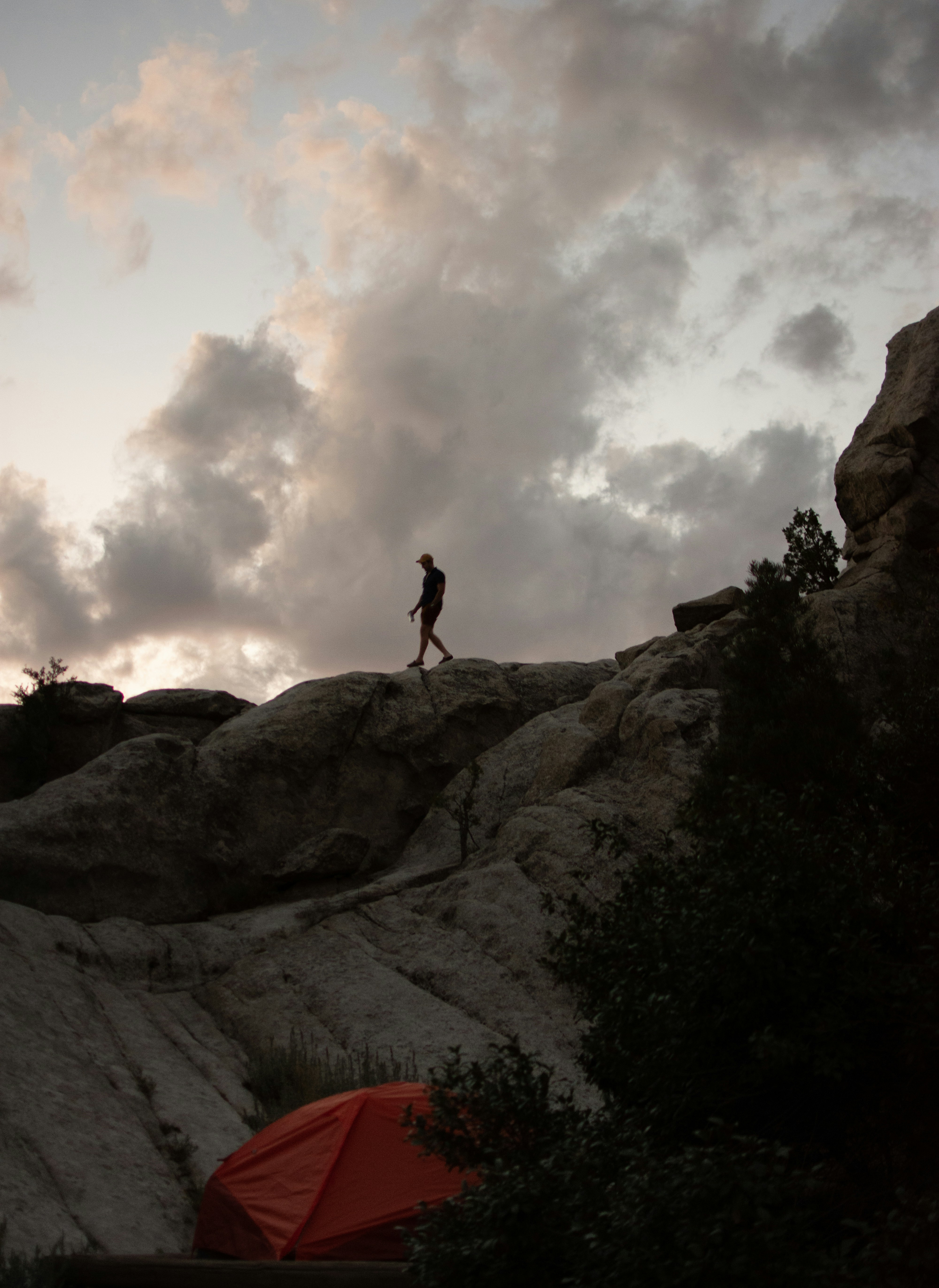 Dusk on Granite Ridge: A lone figure traverses the edge