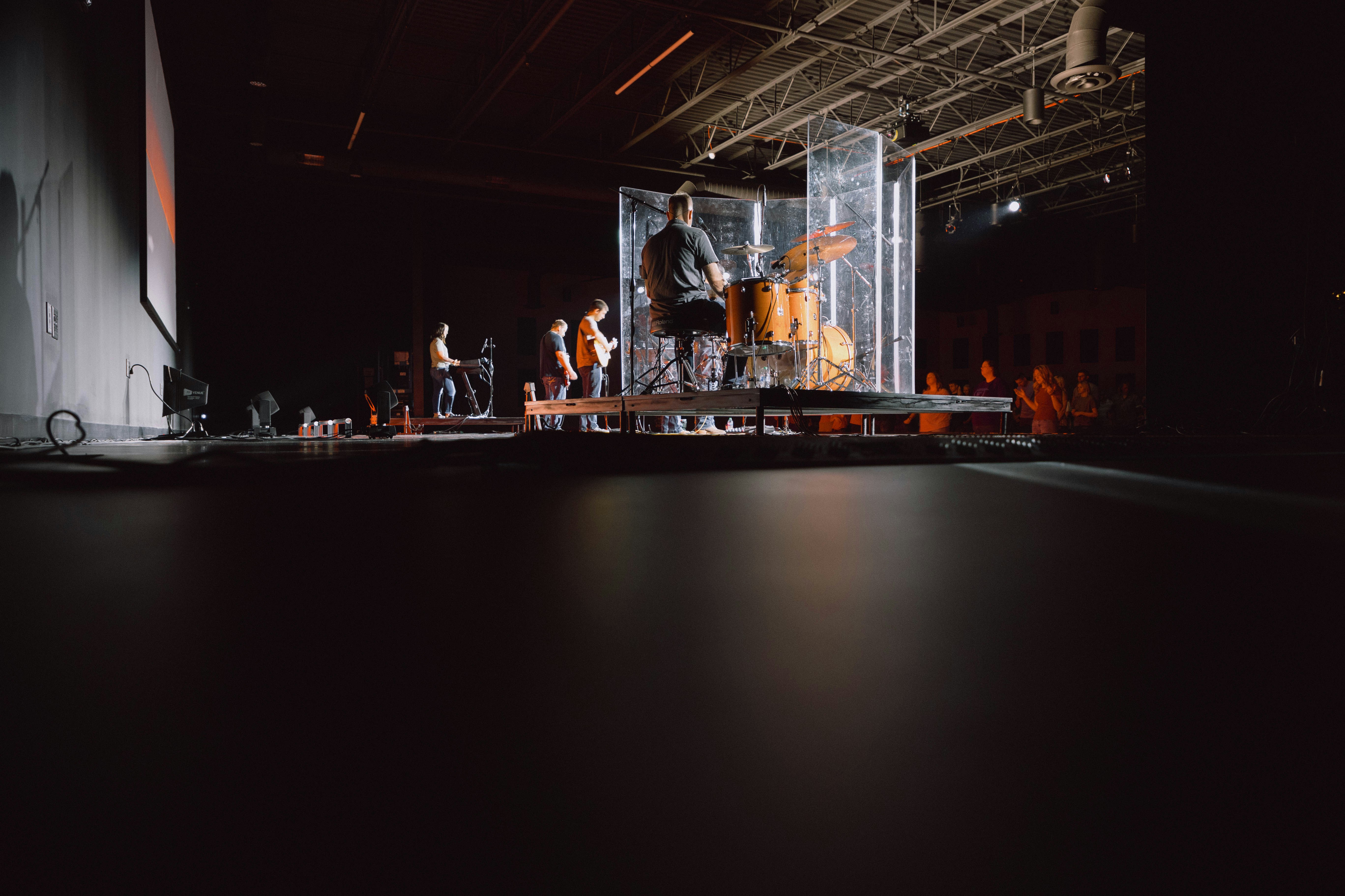 A group of people standing on top of a stage photo – Free Stage Image ...