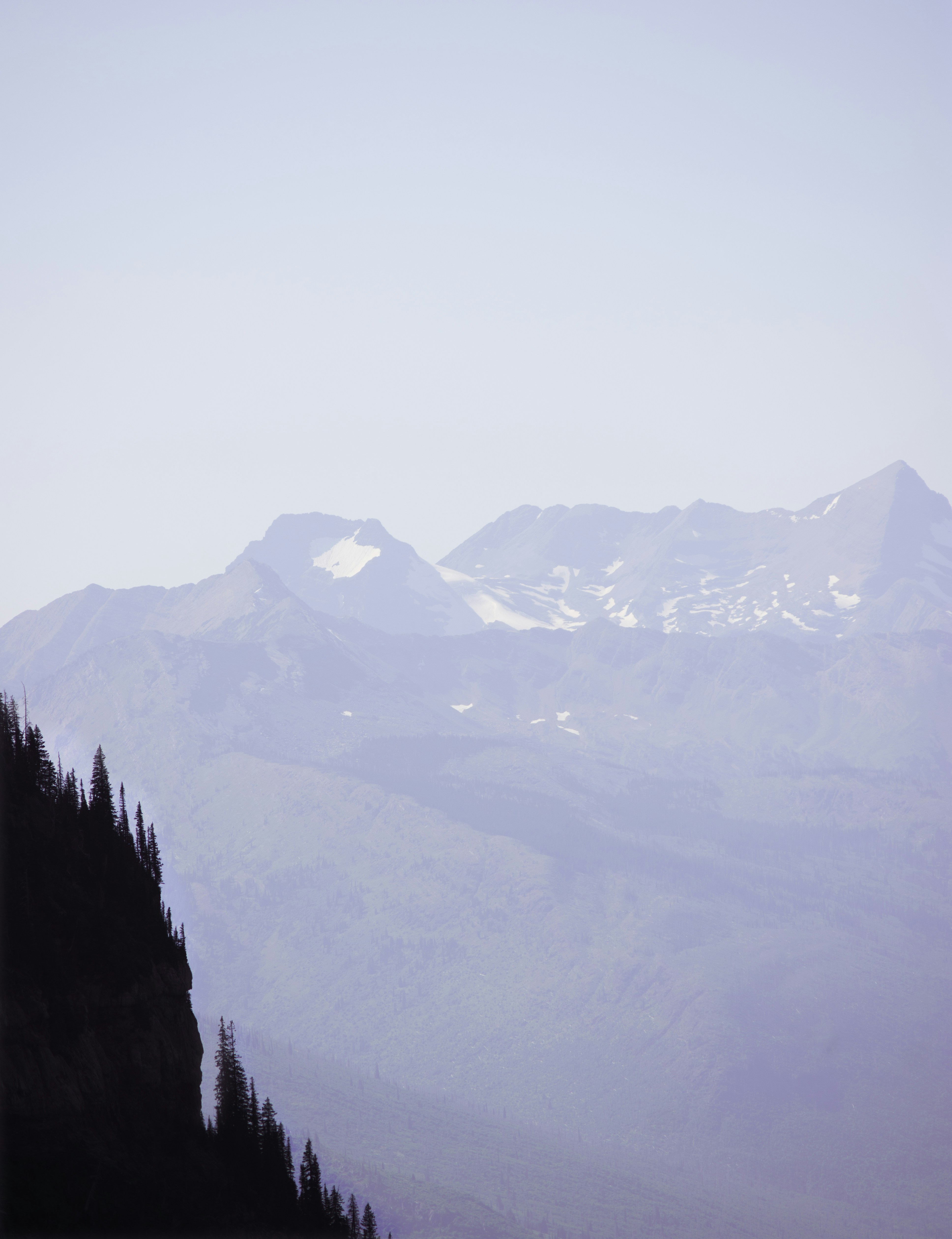 Above the Mist: Snow-Capped Peaks and a Shadowed Foreground