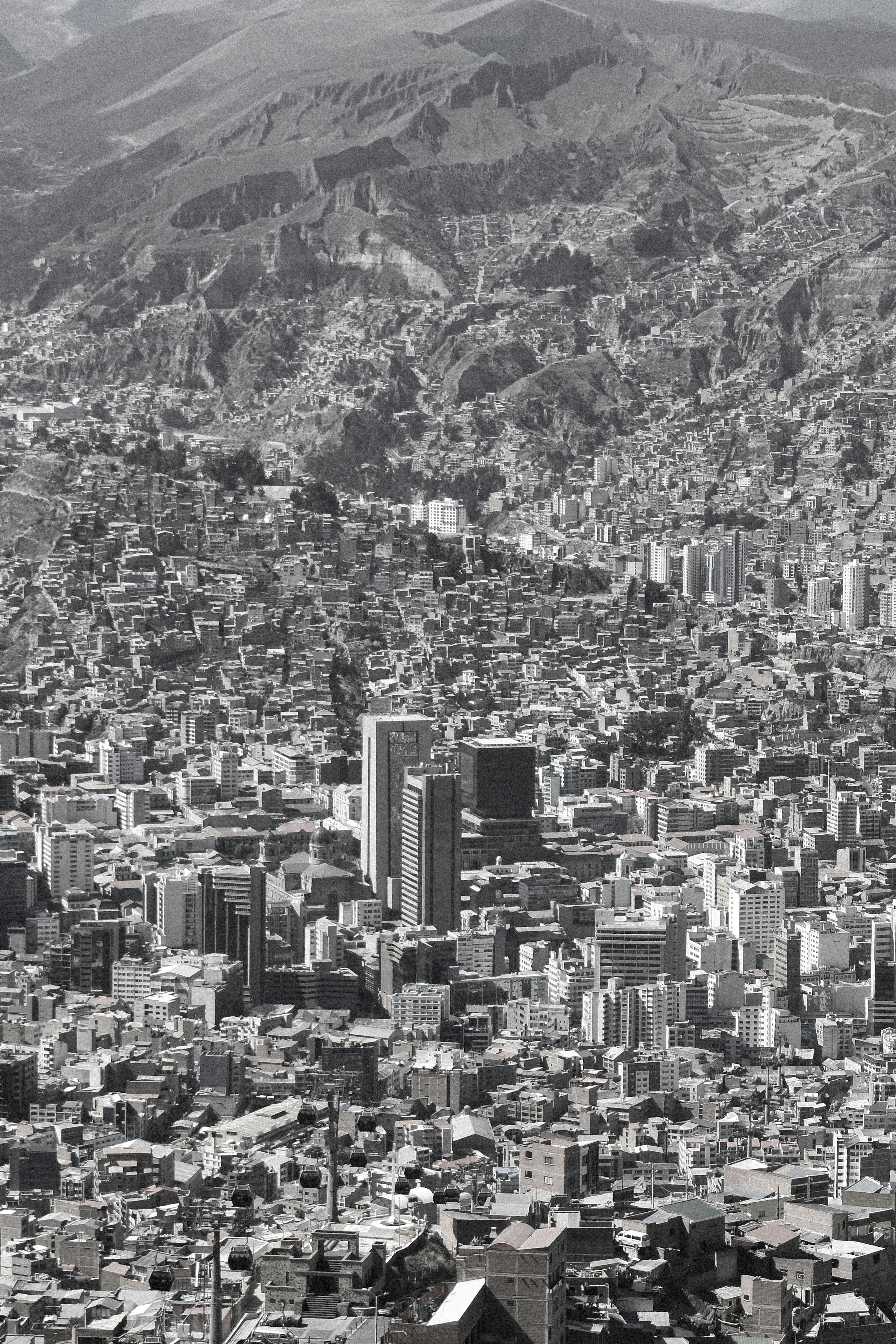 Concrete Cascade Between Mountain Slopes: An Aerial Portrait of a Dense City