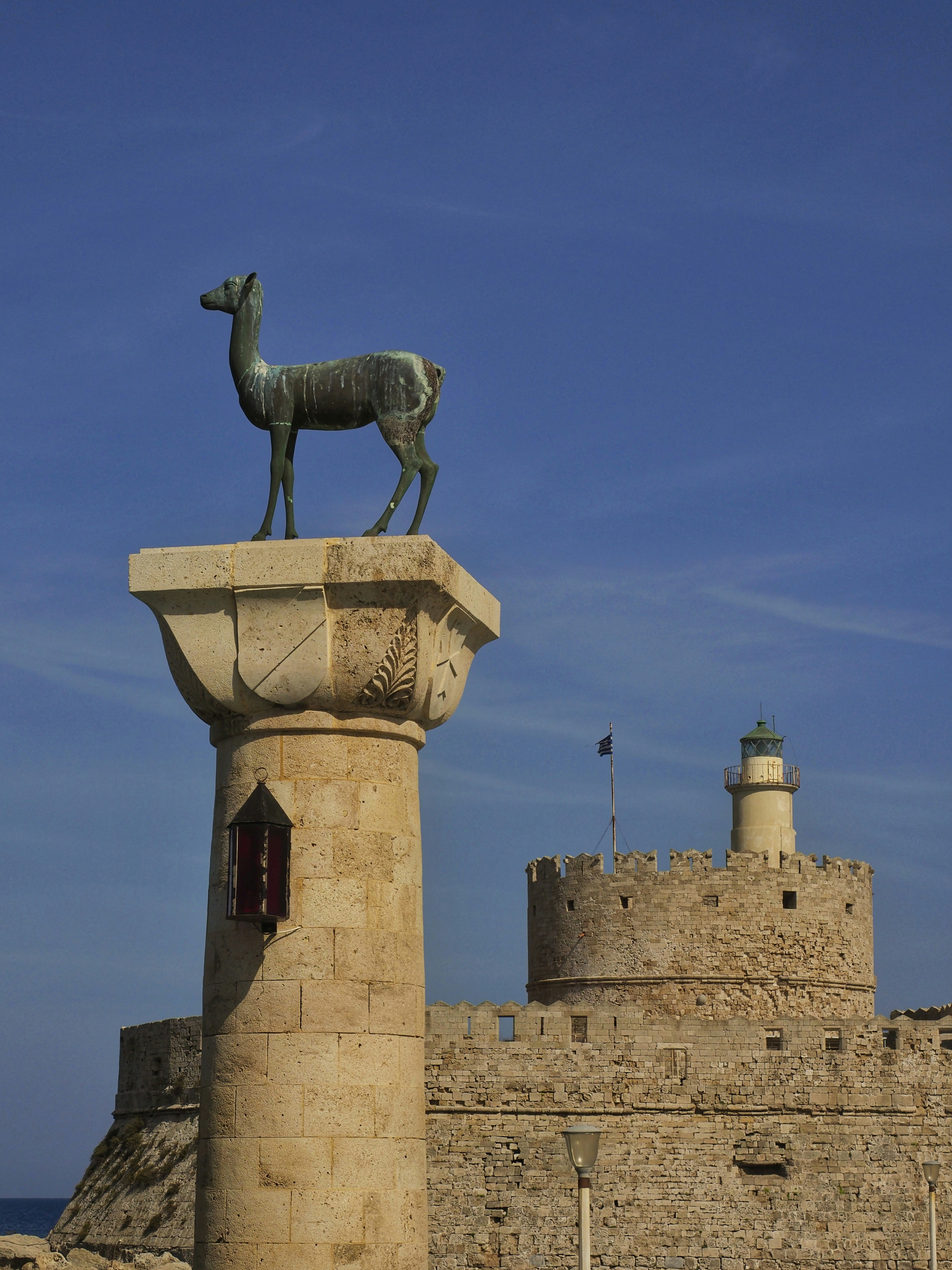 A statue of a goat on top of a tower photo – Free Castle Image on Unsplash