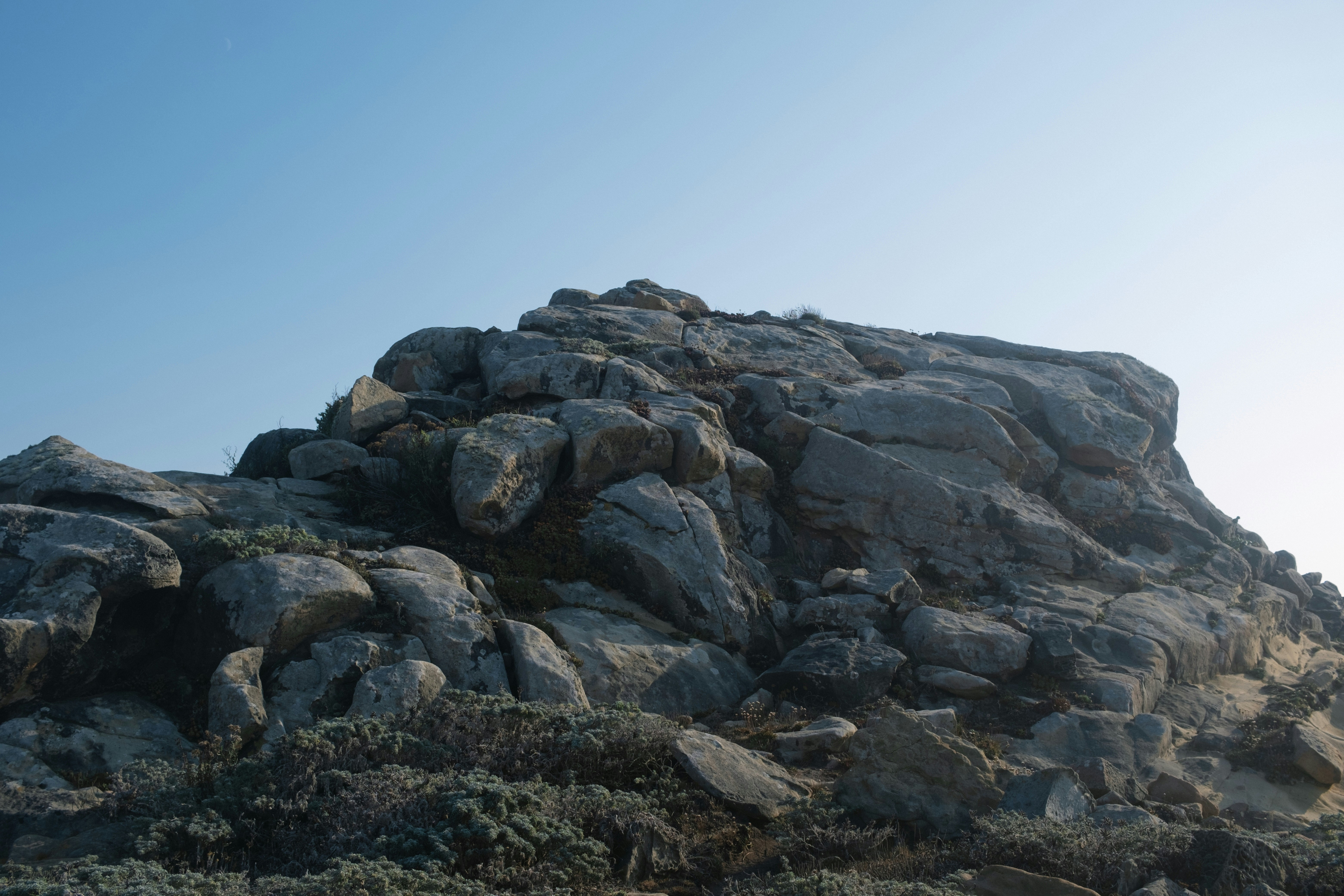 A large rock formation with a sky background photo – Free Rock Image on ...