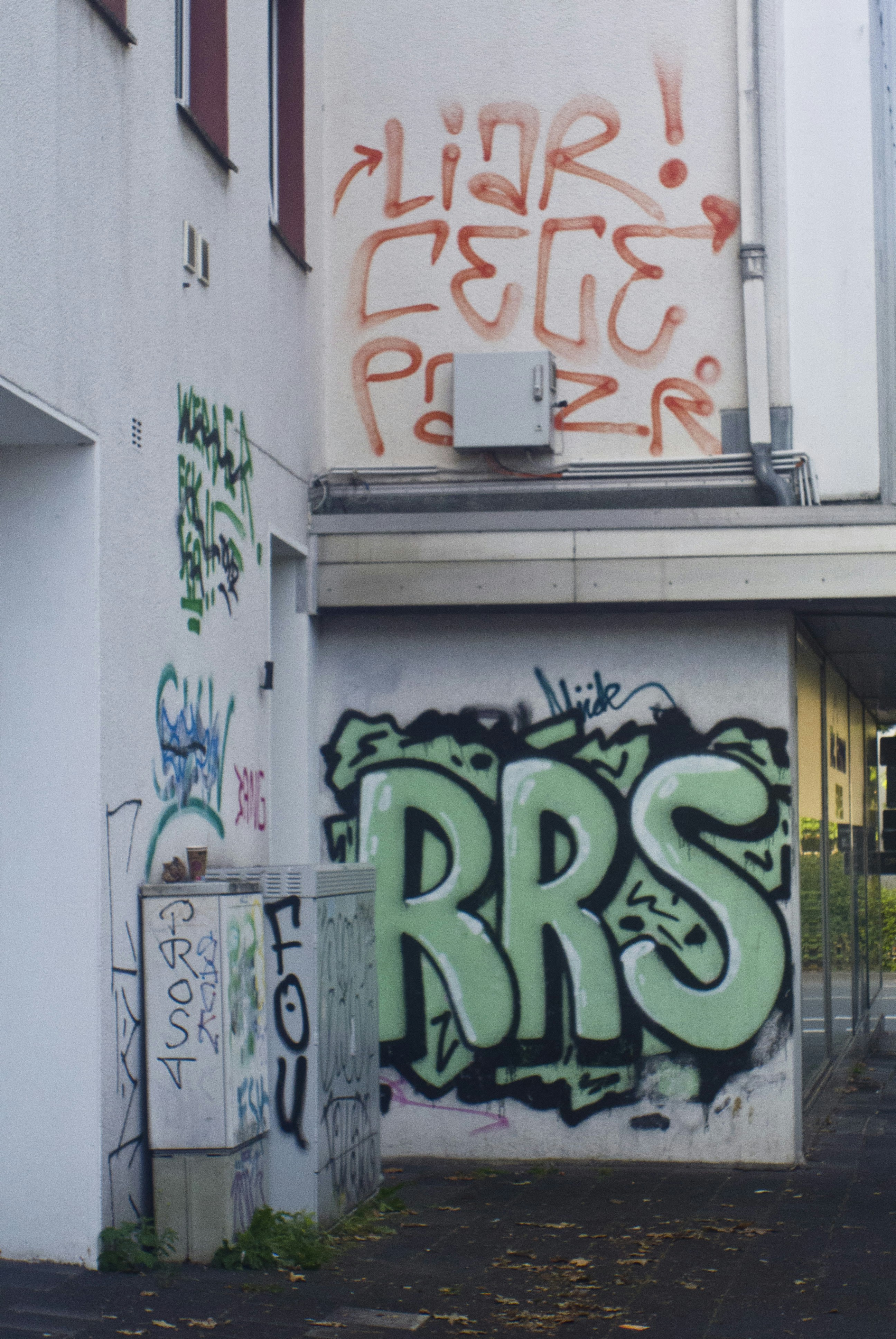 Vibrant graffiti covers a building exterior, showcasing bold lettering and colorful designs that reflect urban culture and self-expression.