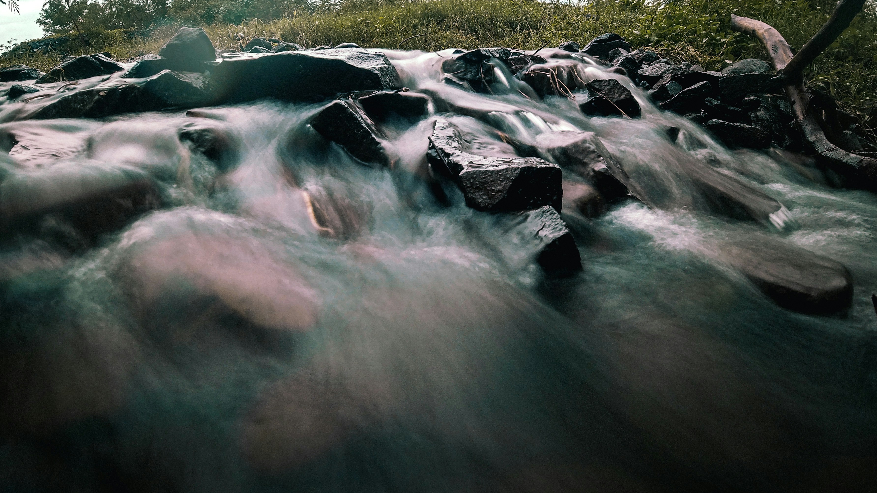 A stream of water running over rocks in a forest photo – Free Waterfall ...