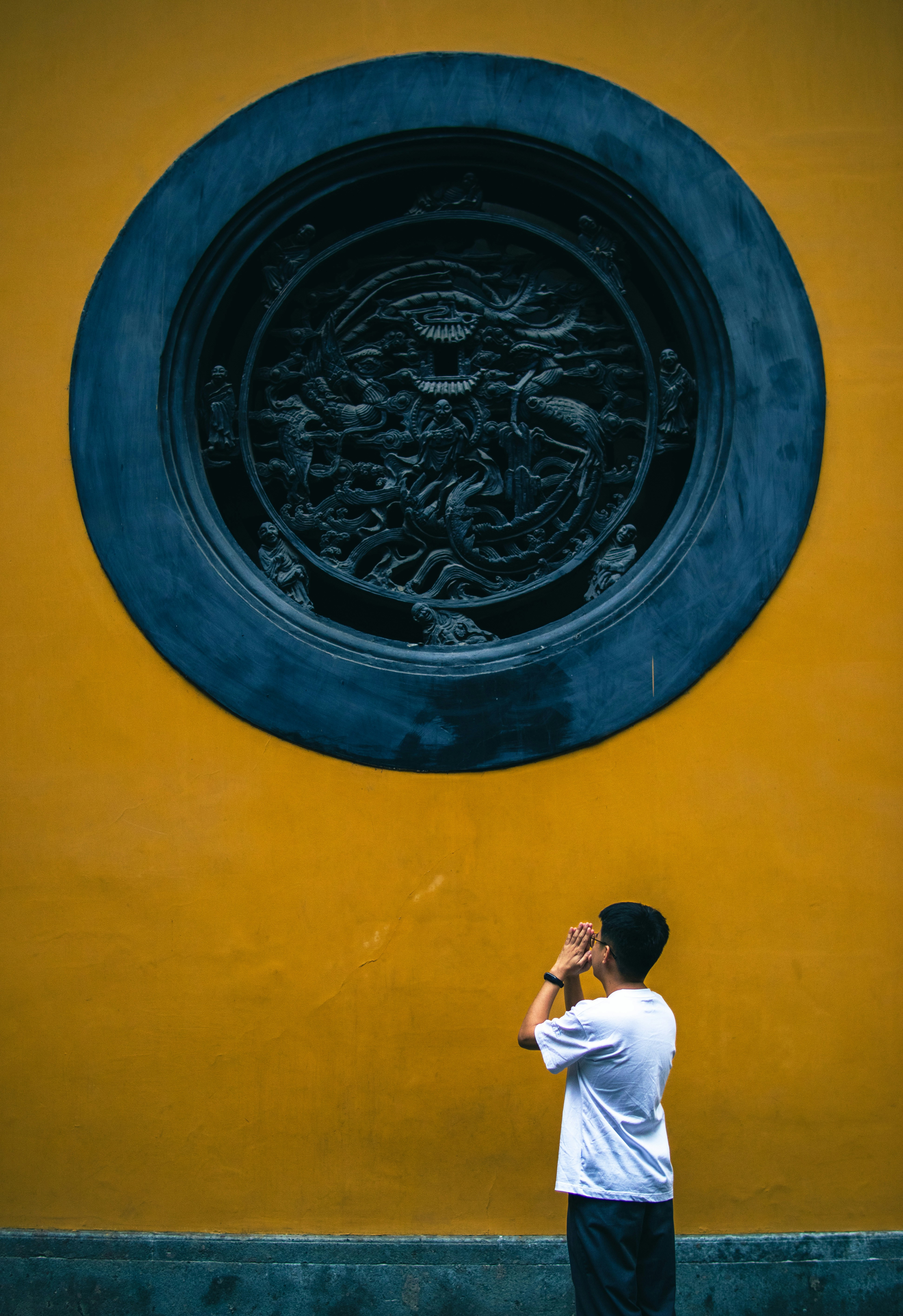 The Dragon Circle: Portrait against a Sunlit Amber Wall