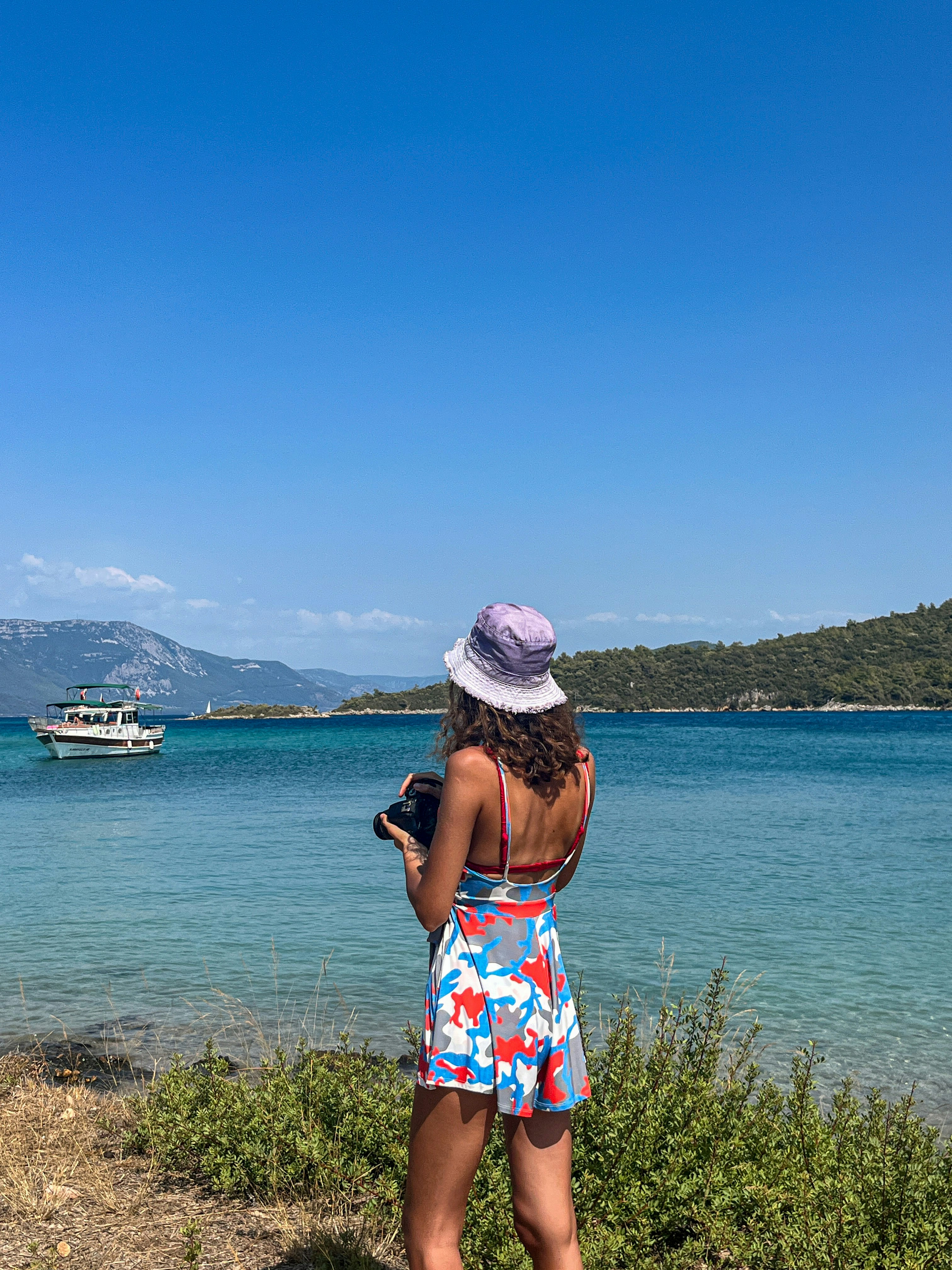 Sunlit Beach Portrait: Capturing a Photographer in Coral-Print Shorts