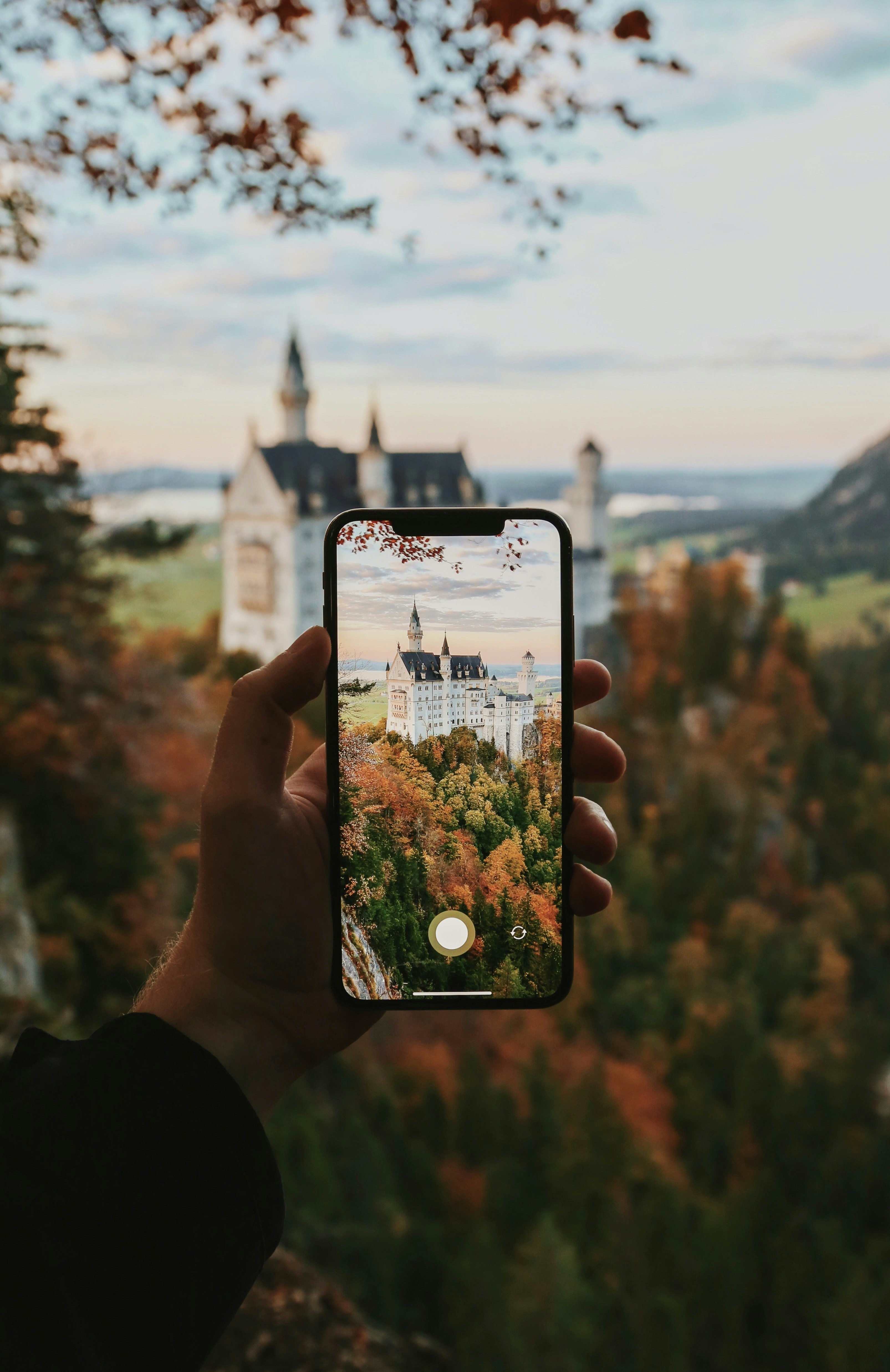 Autumn Castle in Focus: A Handheld Moment Framing a Dreamlike Fortress