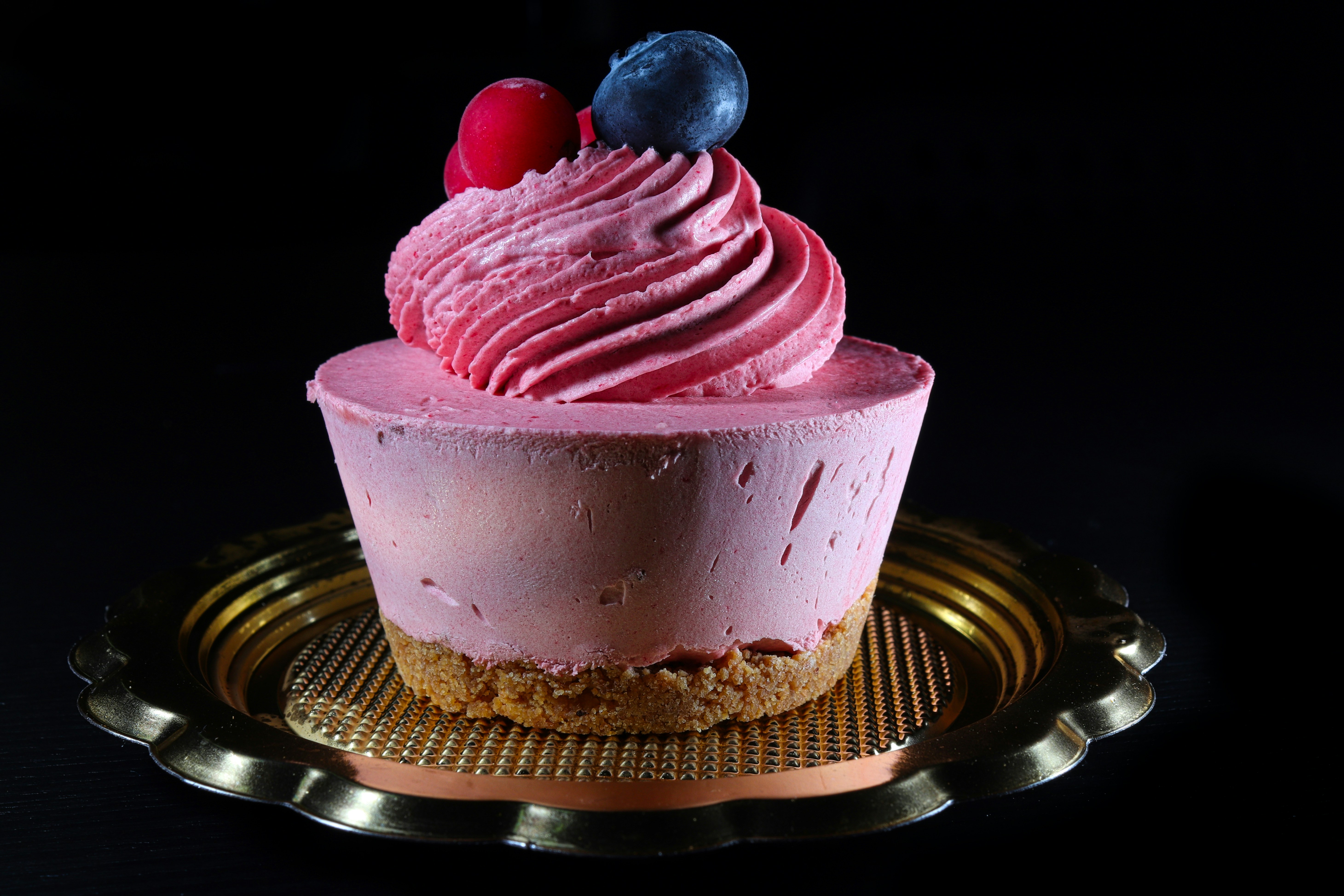 Berry-Topped Pink Velvet Cupcake on a Copper Plate