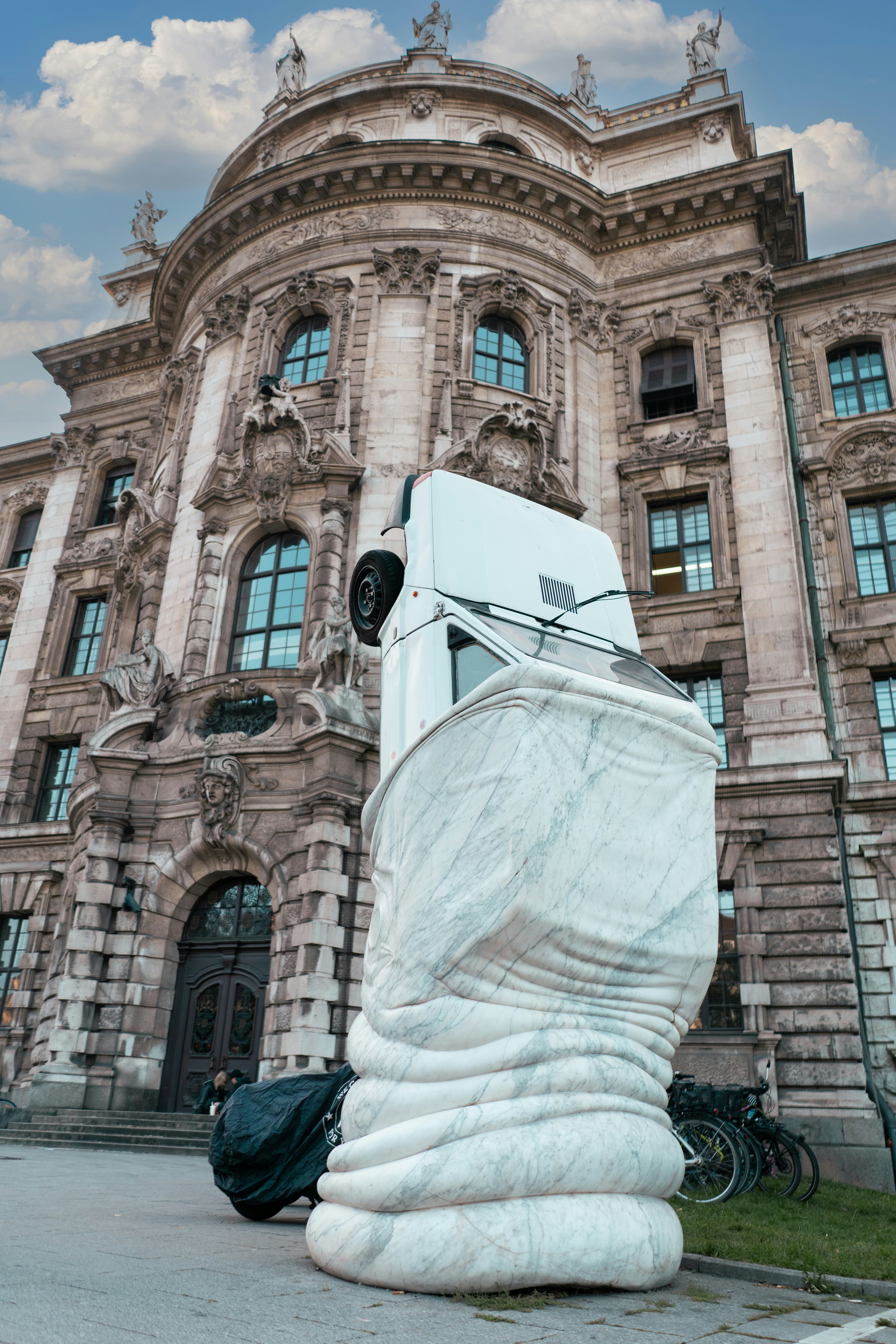 Giants of Marble: A Carrara Spine Stands Before a Baroque Facade