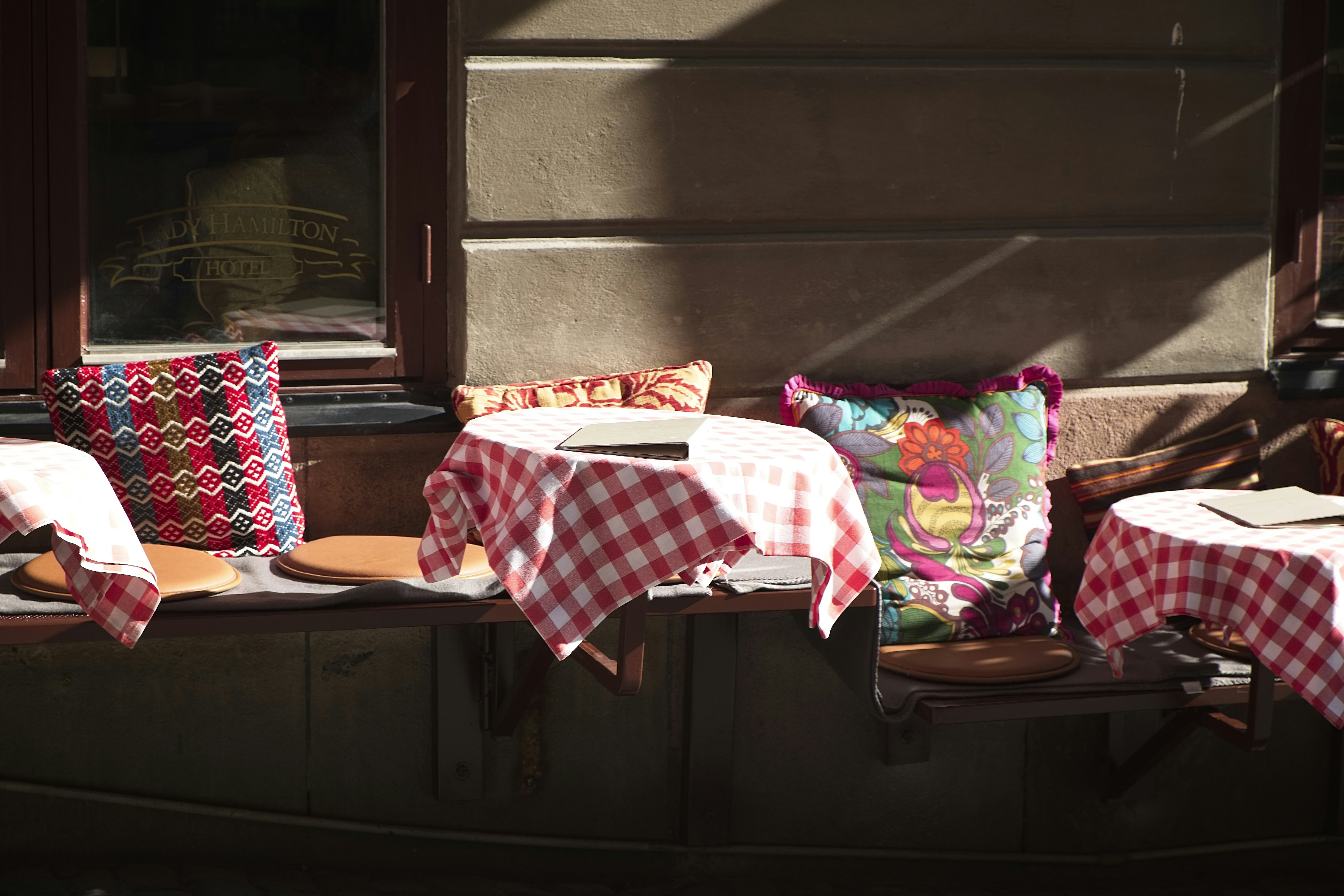 Sunlit Café Secrets: Red-Check Tables in Quiet Street
