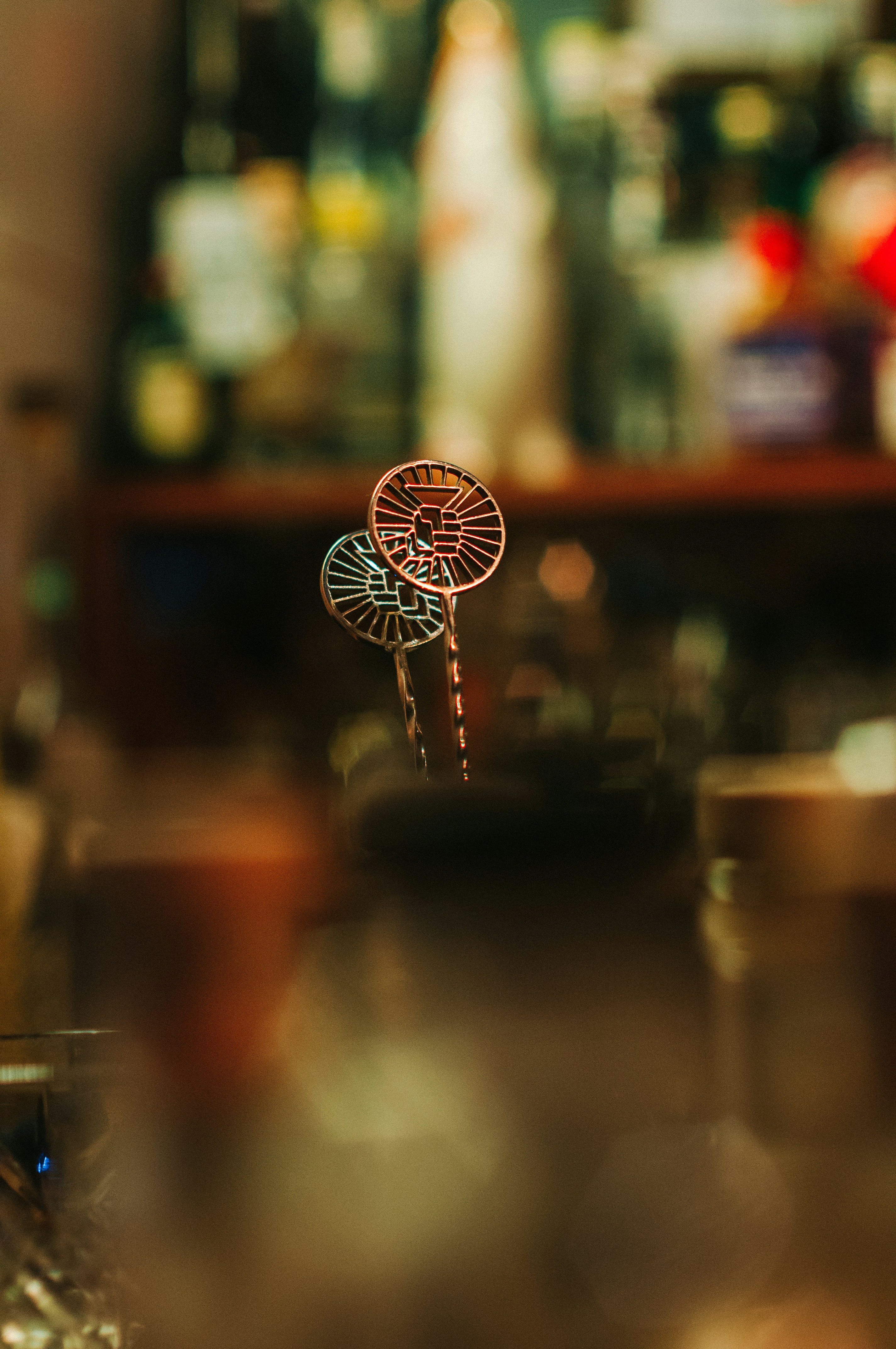 Circular Spirals Above the Bar: Copper Coils in a Dimly Lit Scene