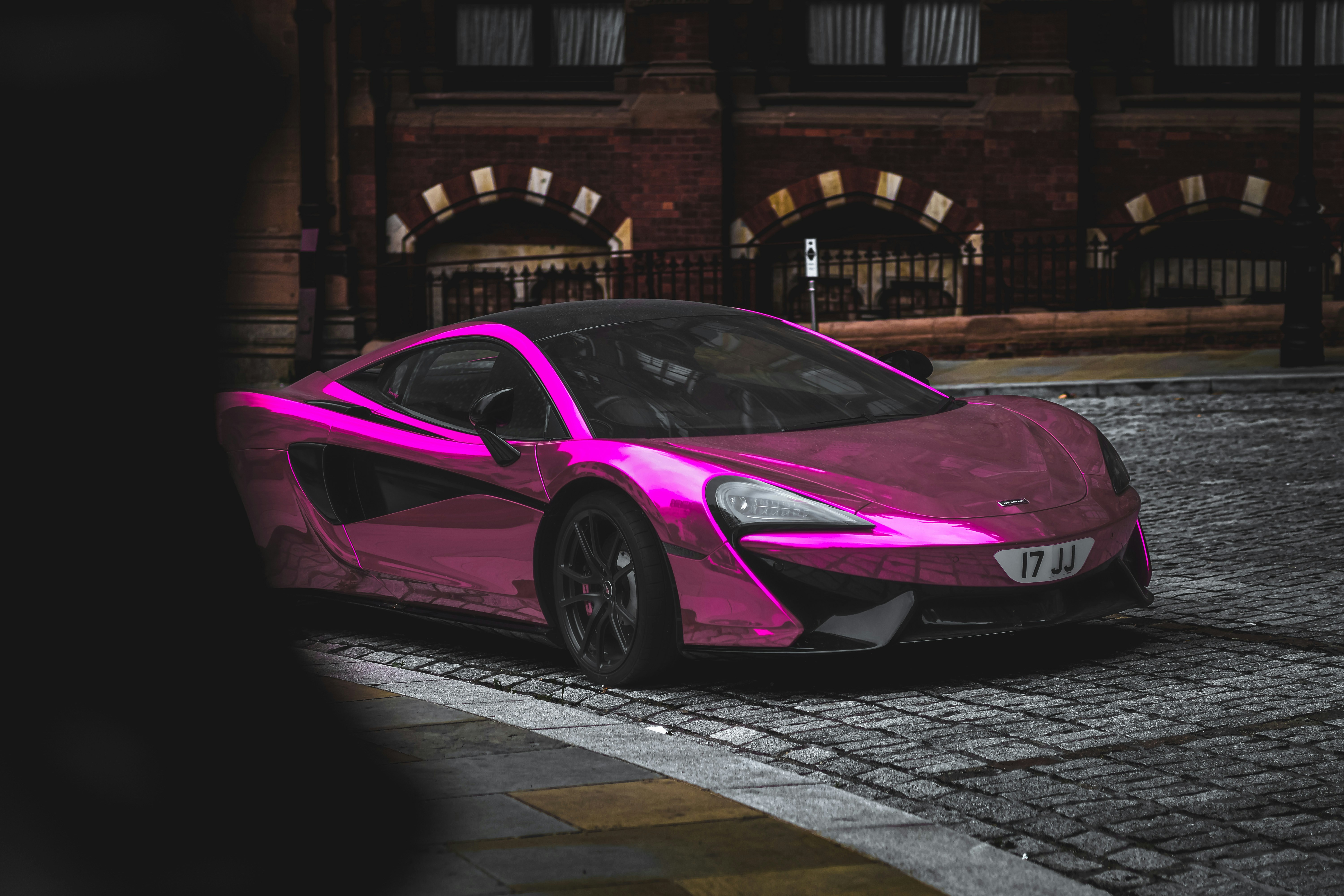 Chromatic Velocity: Neon Pink McLaren Illuminates a Cobblestone Night