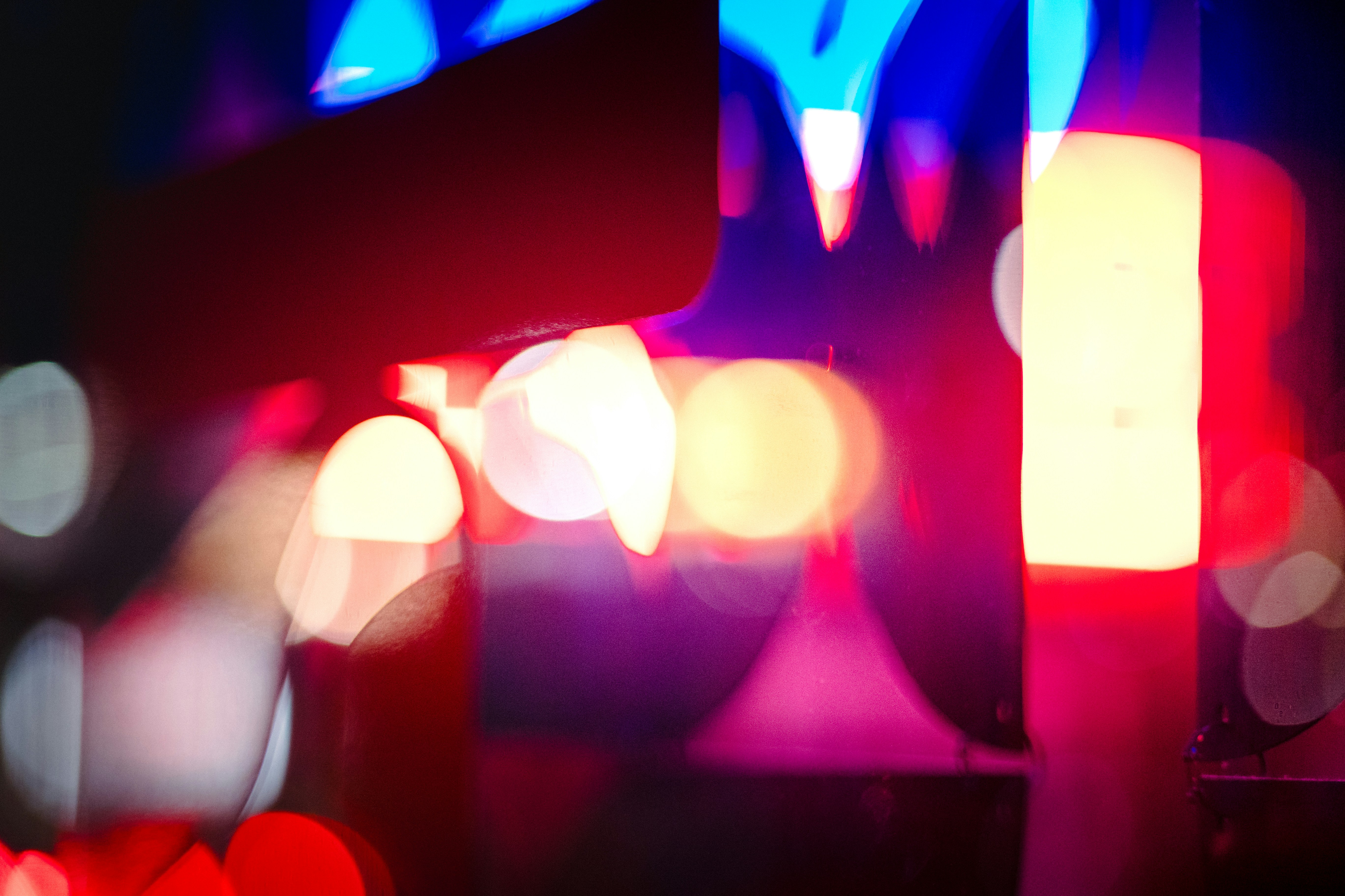 Neon Bokeh: Red and Blue Sirens Weave Through Night