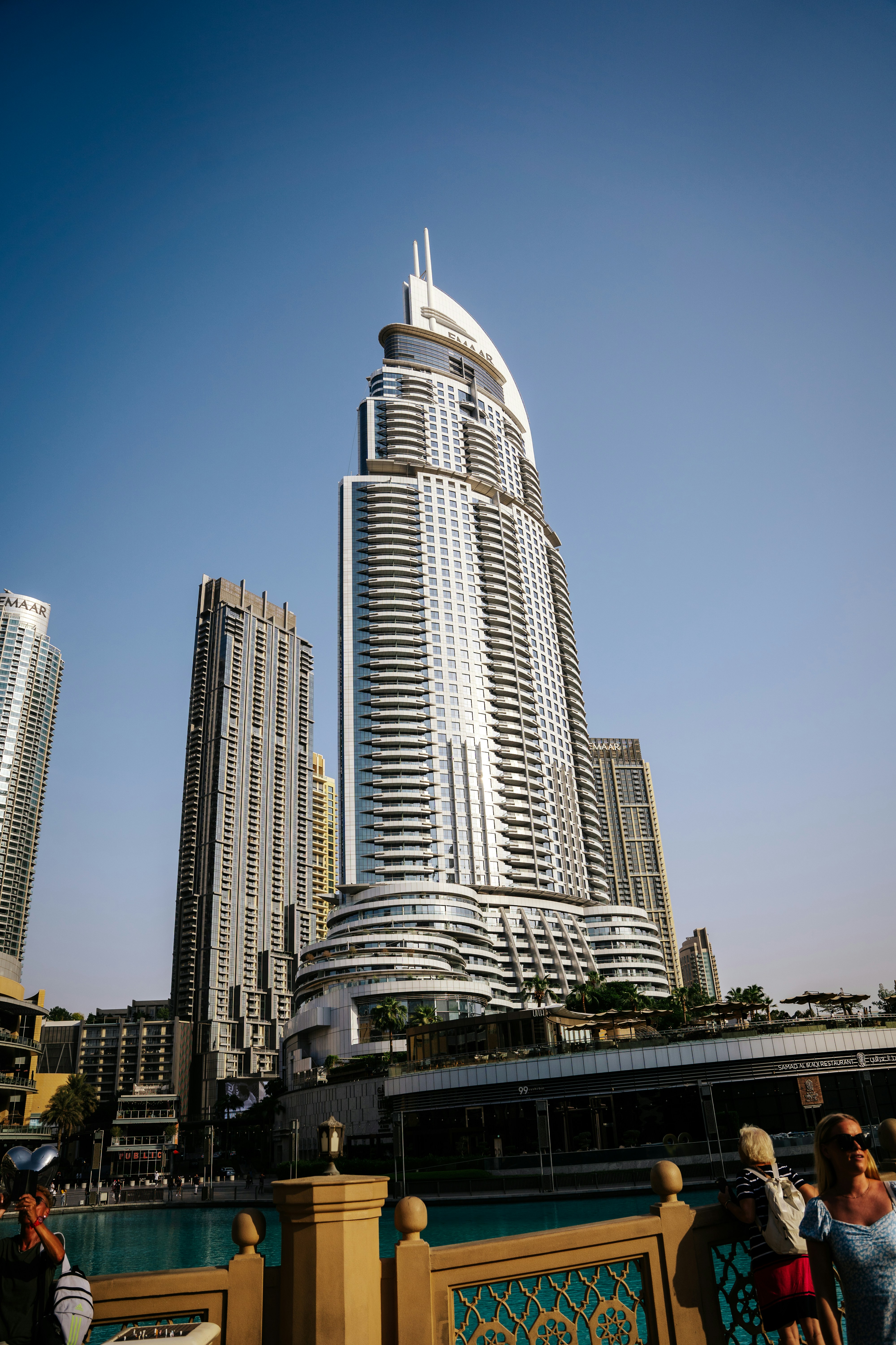A group of people standing in front of a tall building photo – Free ...