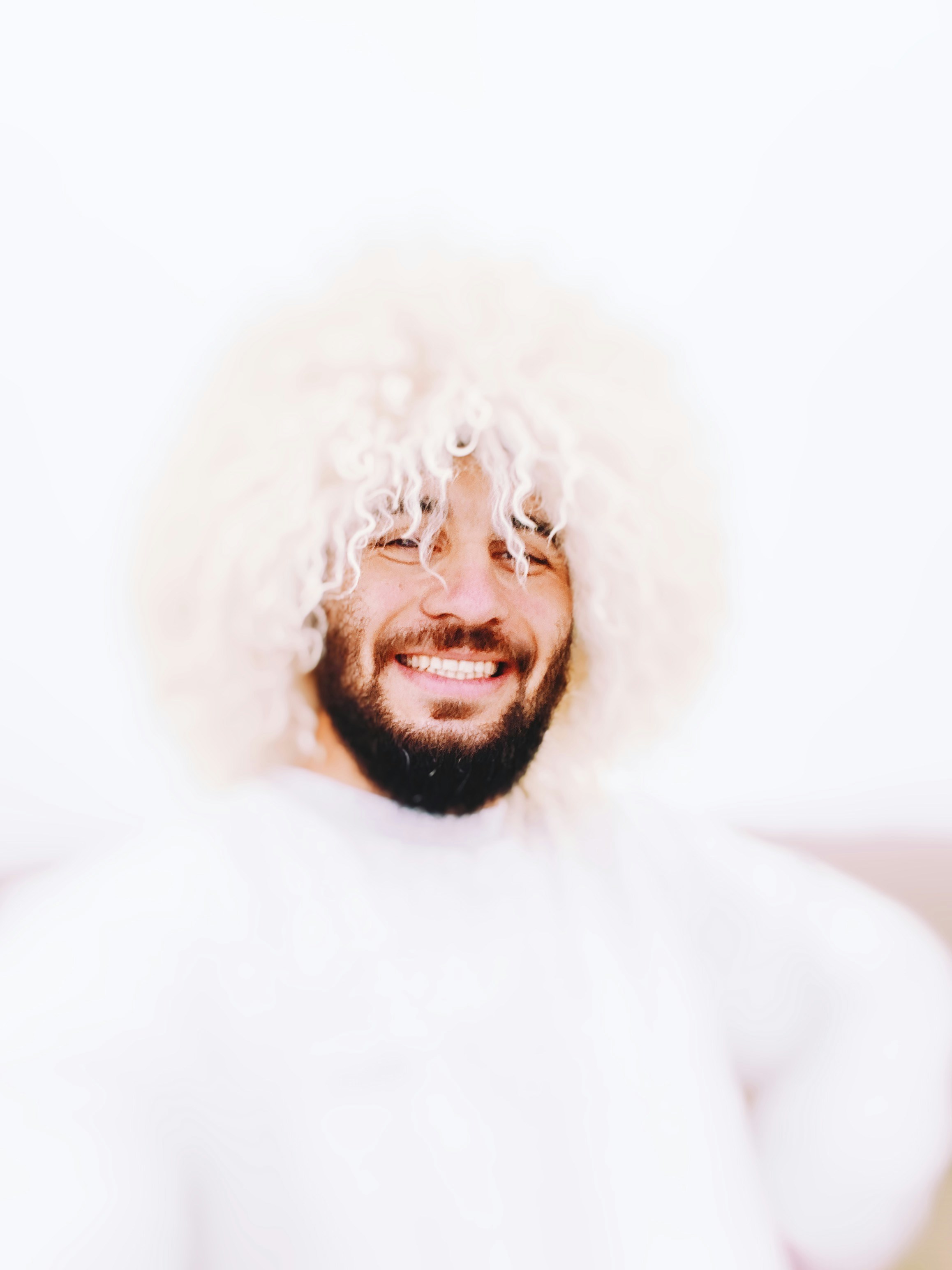 Haloed Curls, Warm Smile: A High-Key Portrait