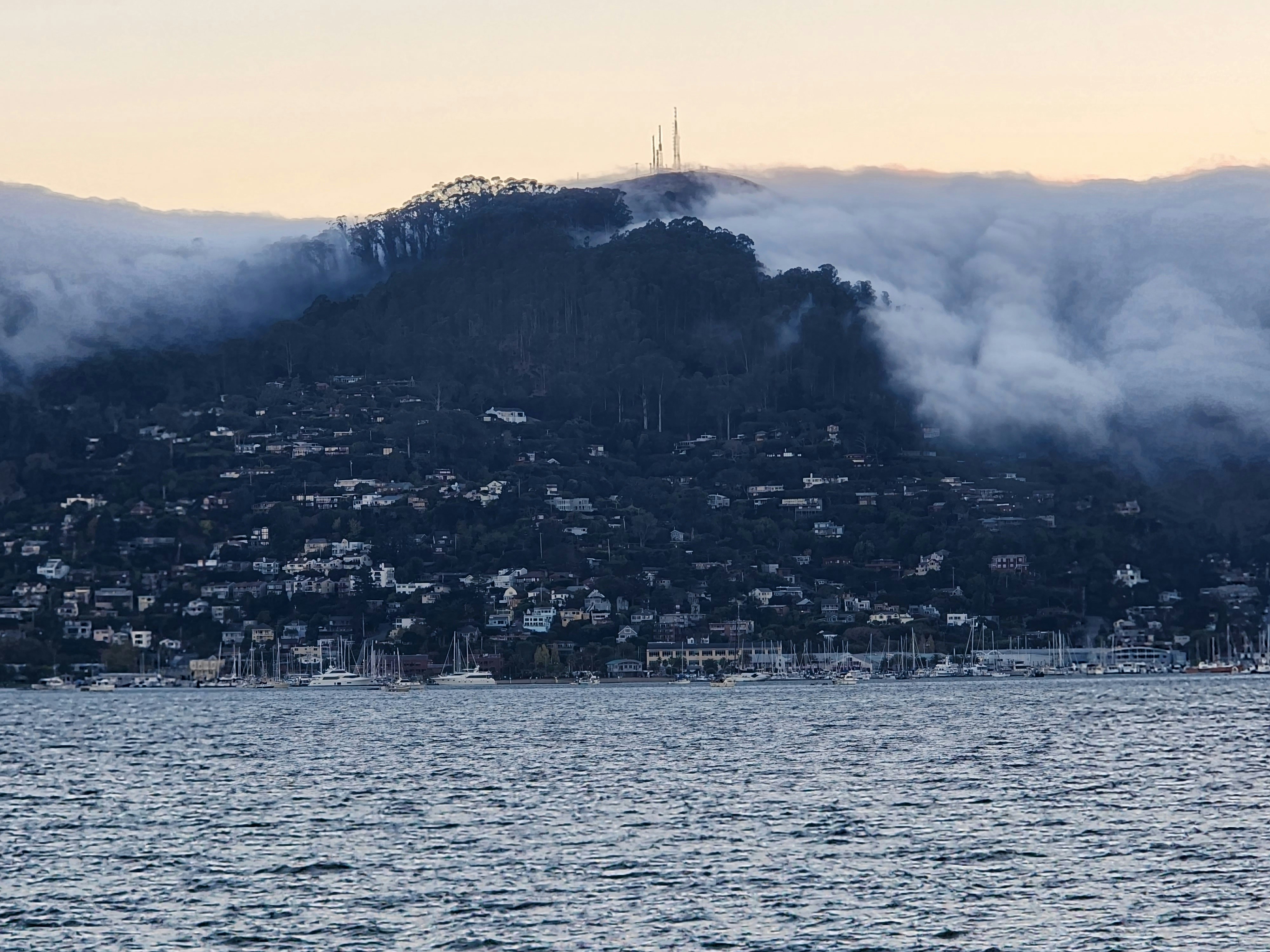 Antennas Crown a Veiled Peak Over a Quiet Marina