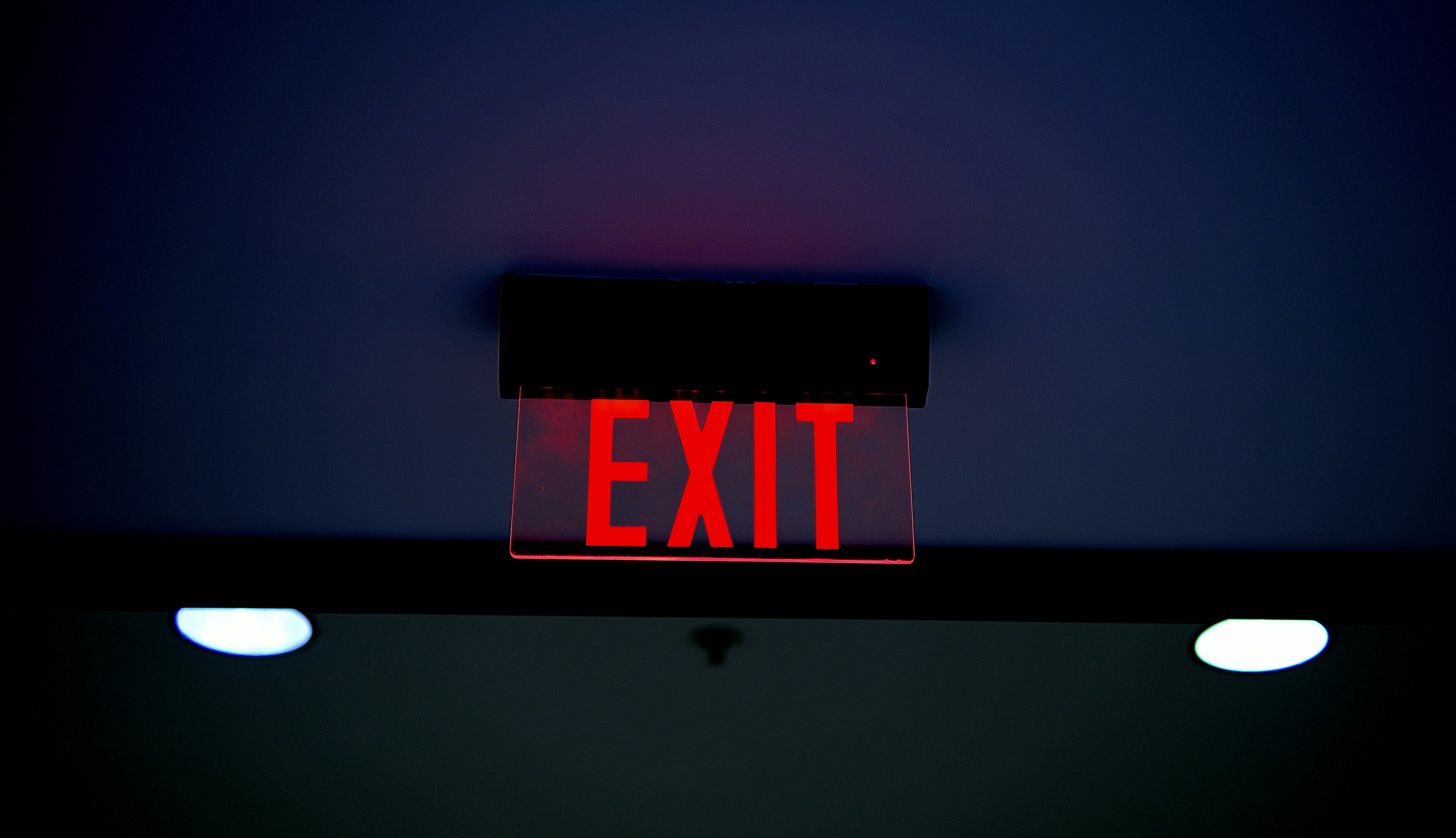 A red exit sign is lit up in the dark photo – Free Charlotte Image on ...