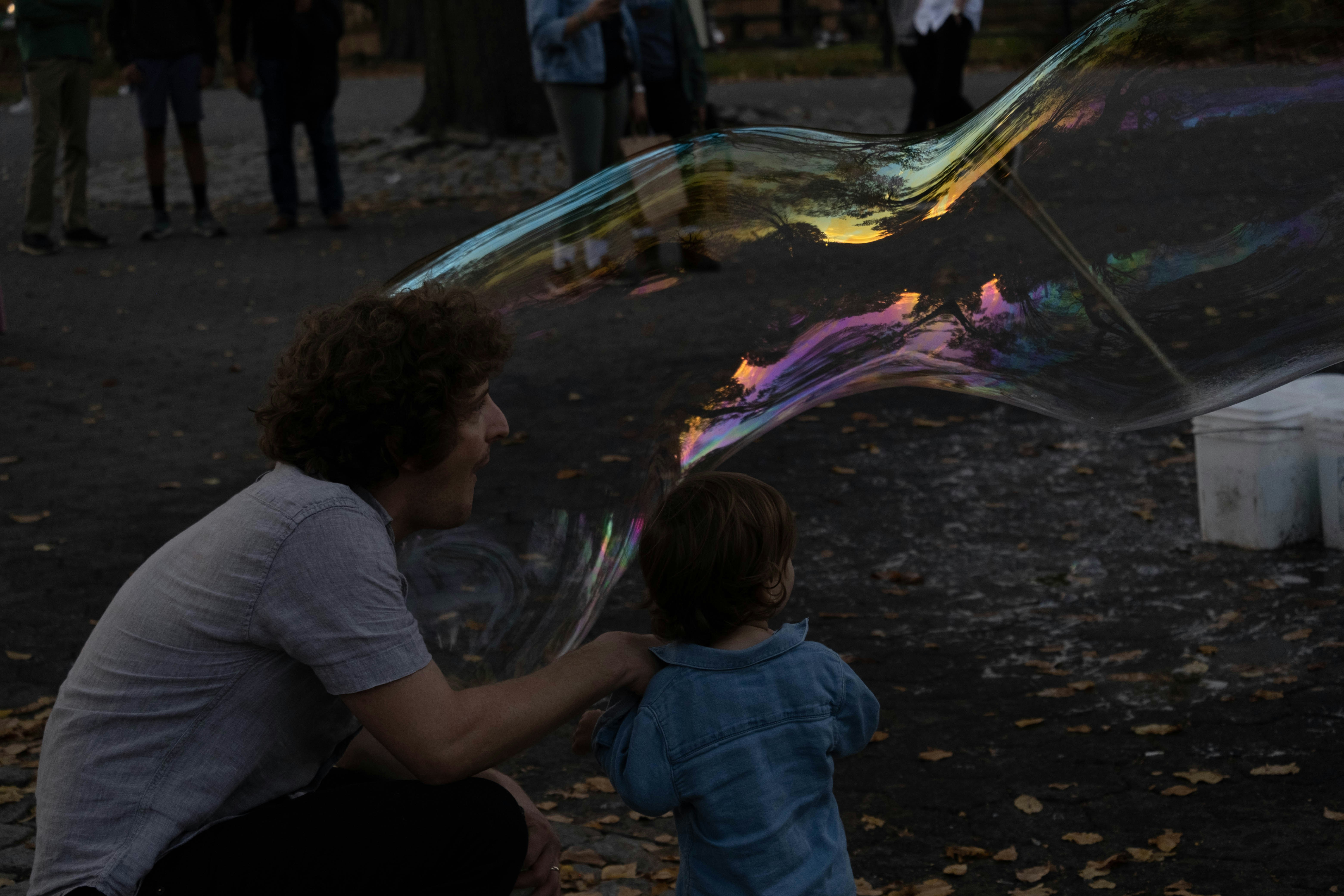 Chasing a Rainbow Bubble: Quiet Park Moment at Dusk