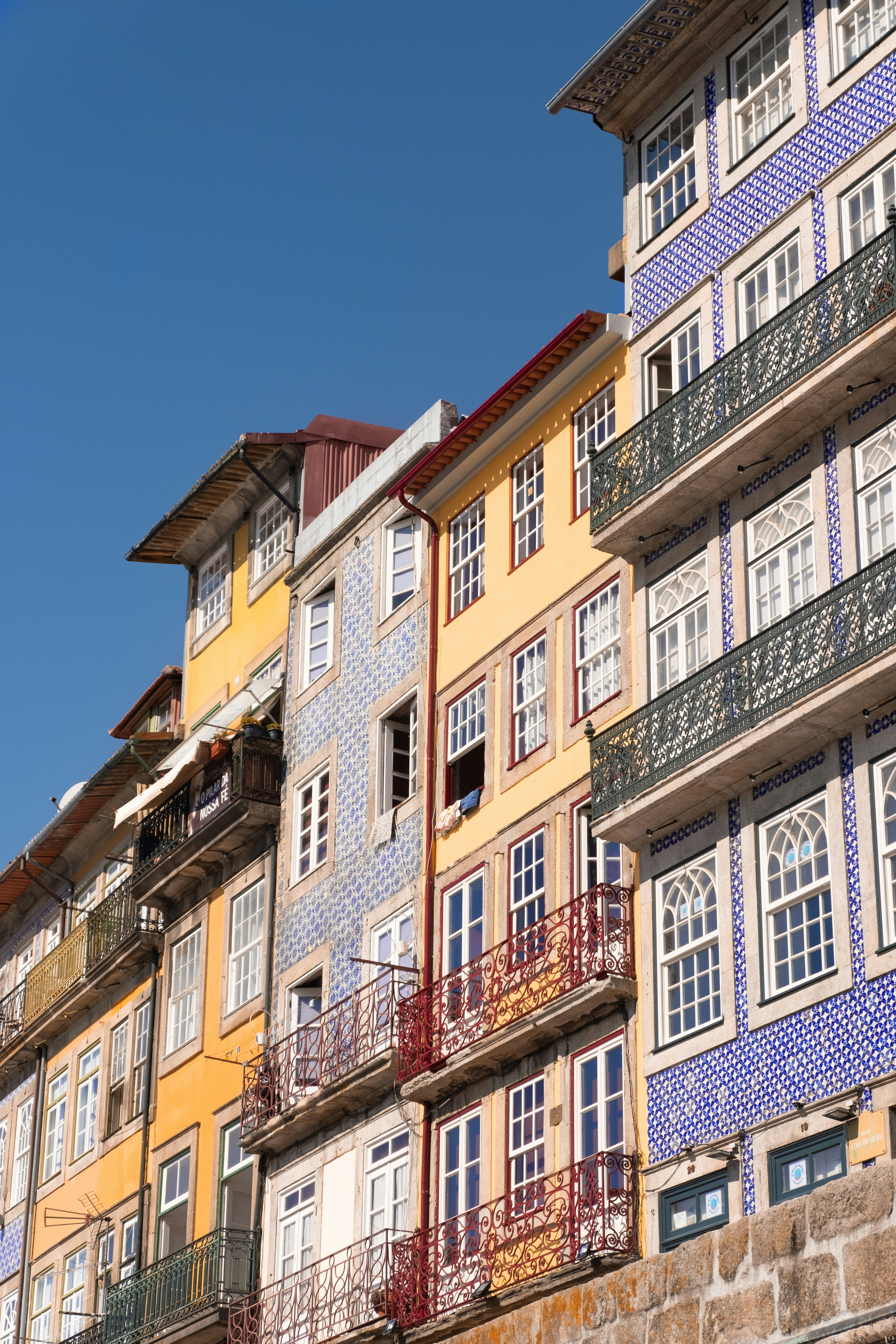 A row of multi - colored buildings with balconies and balconies on ...