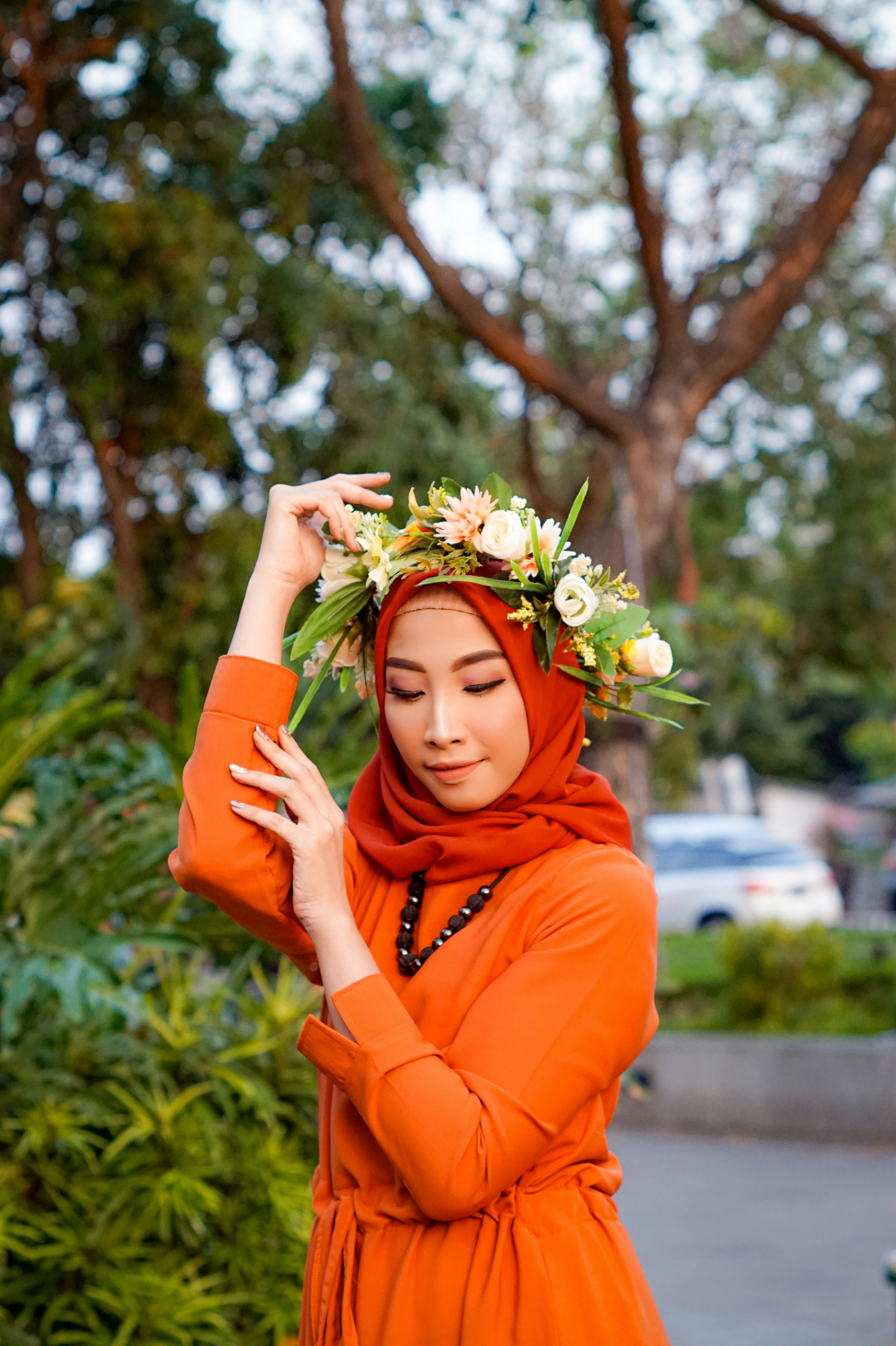 Floral Crown in Fire-Orange Garb: A Park Portrait