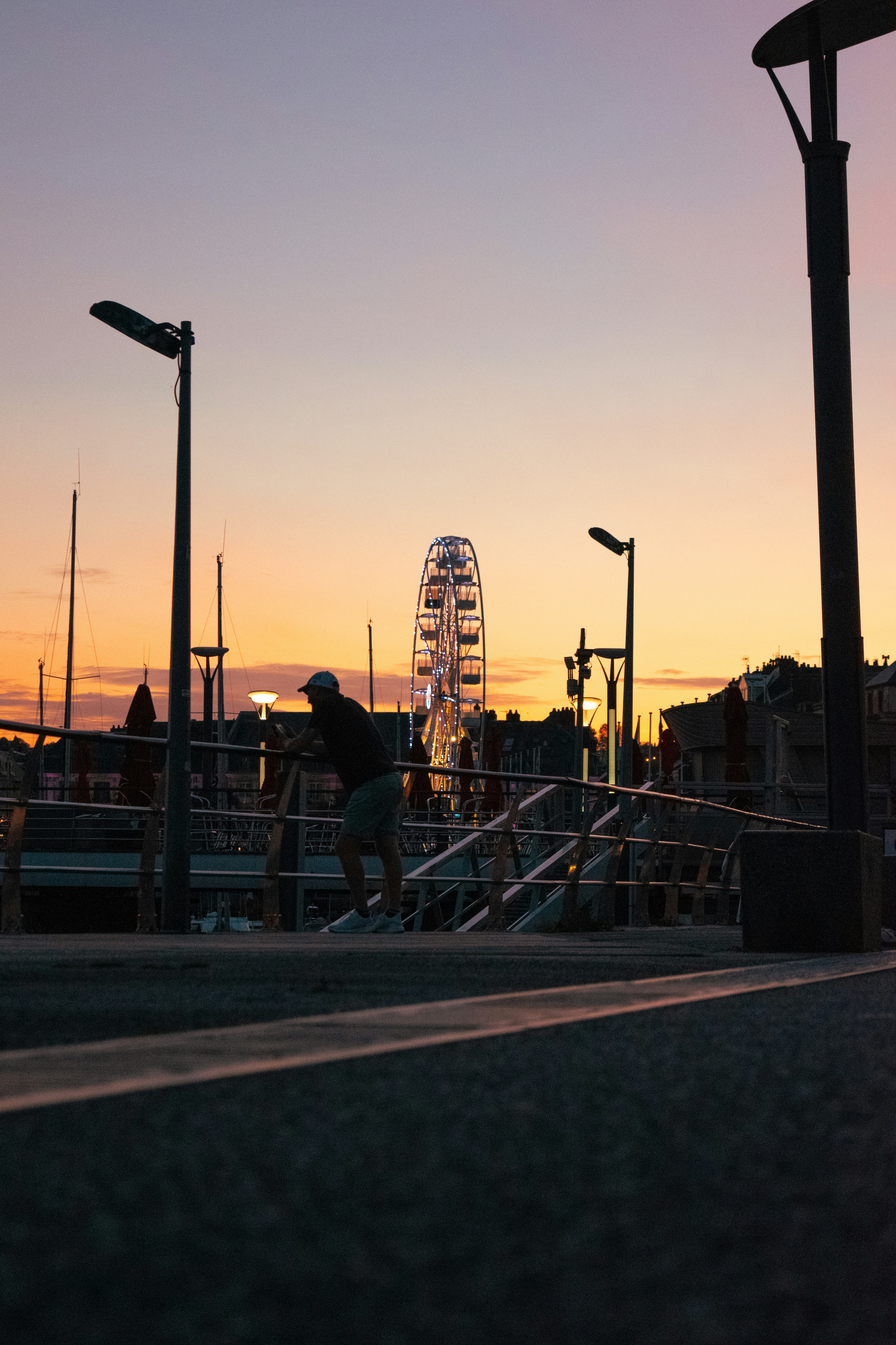 Dusk on the Pier: Silhouette Skater Beneath a Glowing Ferris Wheel