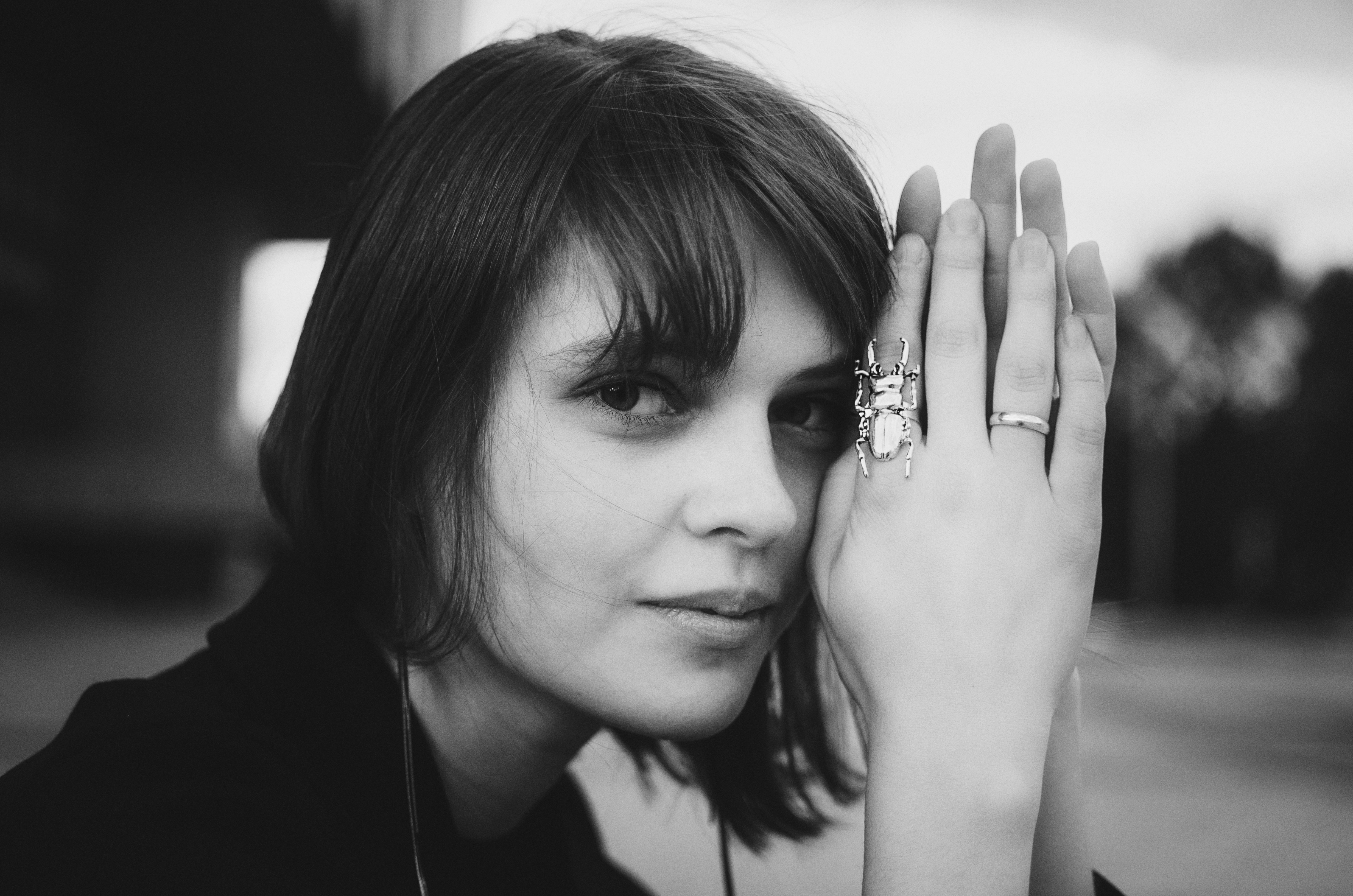 Monochrome Gaze: A Quiet Portrait with a Ringed Hand