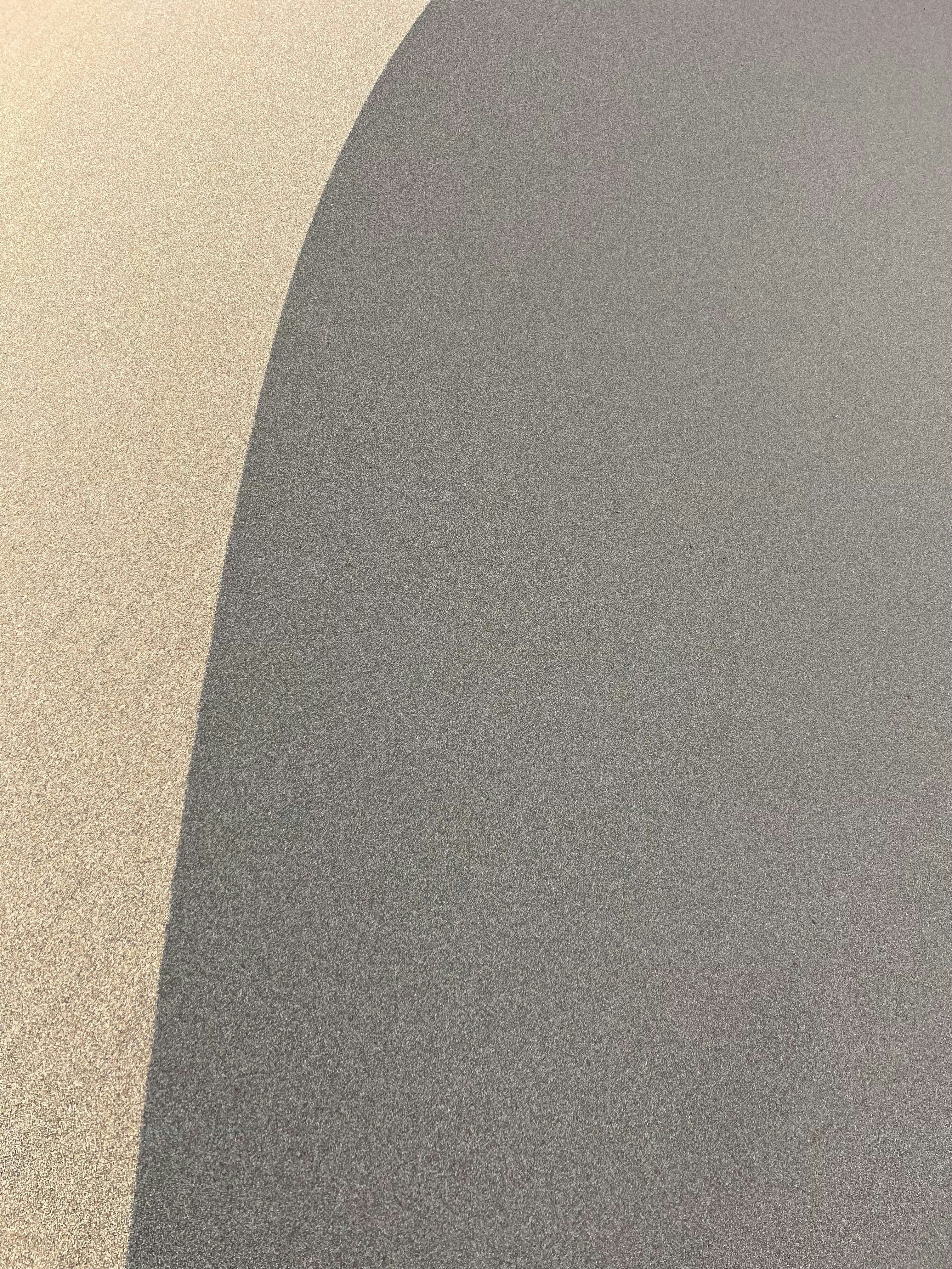 Curved Divide in Desert Light: A Minimal Sand Texture Study