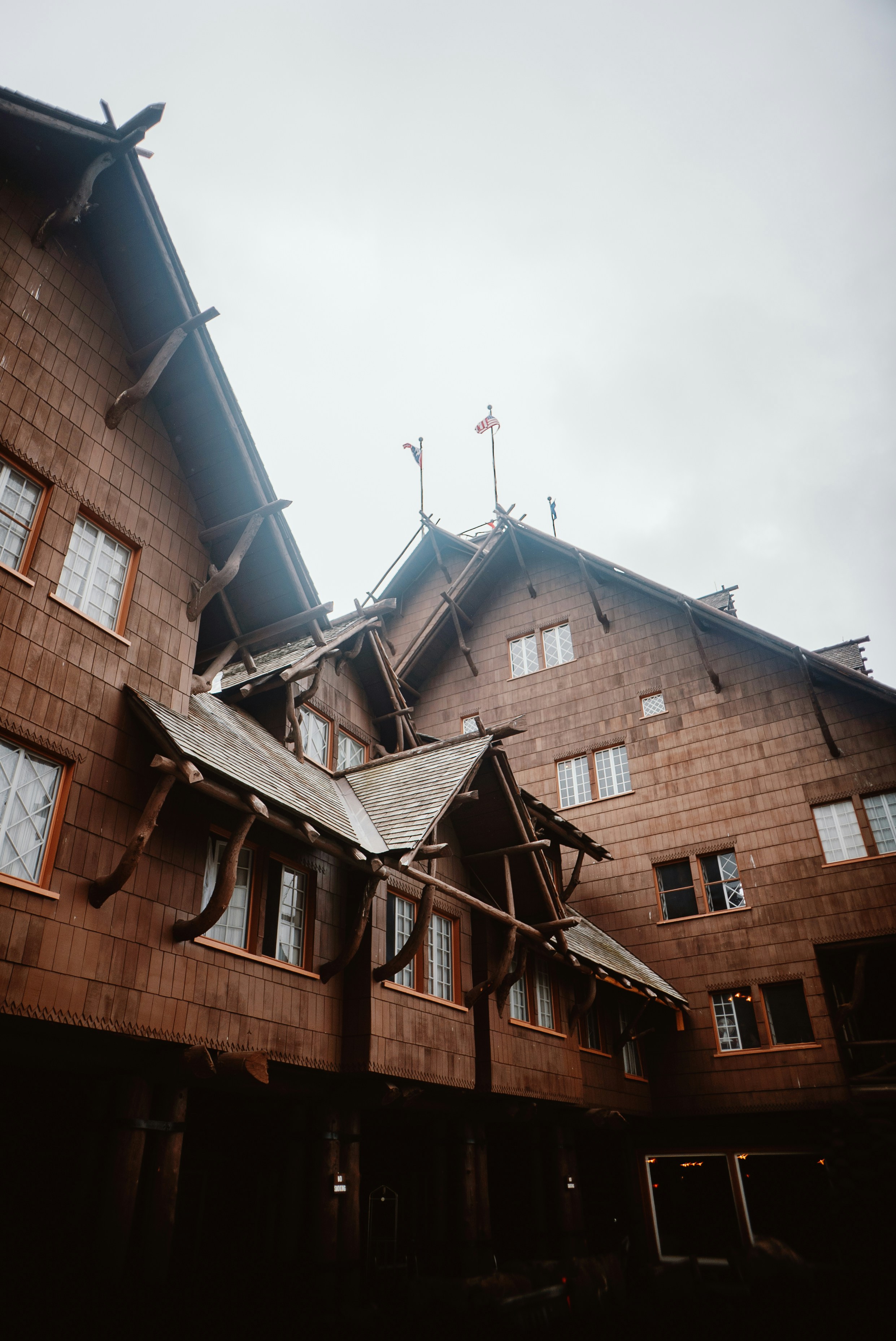 Converging Timber Peaks in a Nordic Courtyard Under Grey Skies