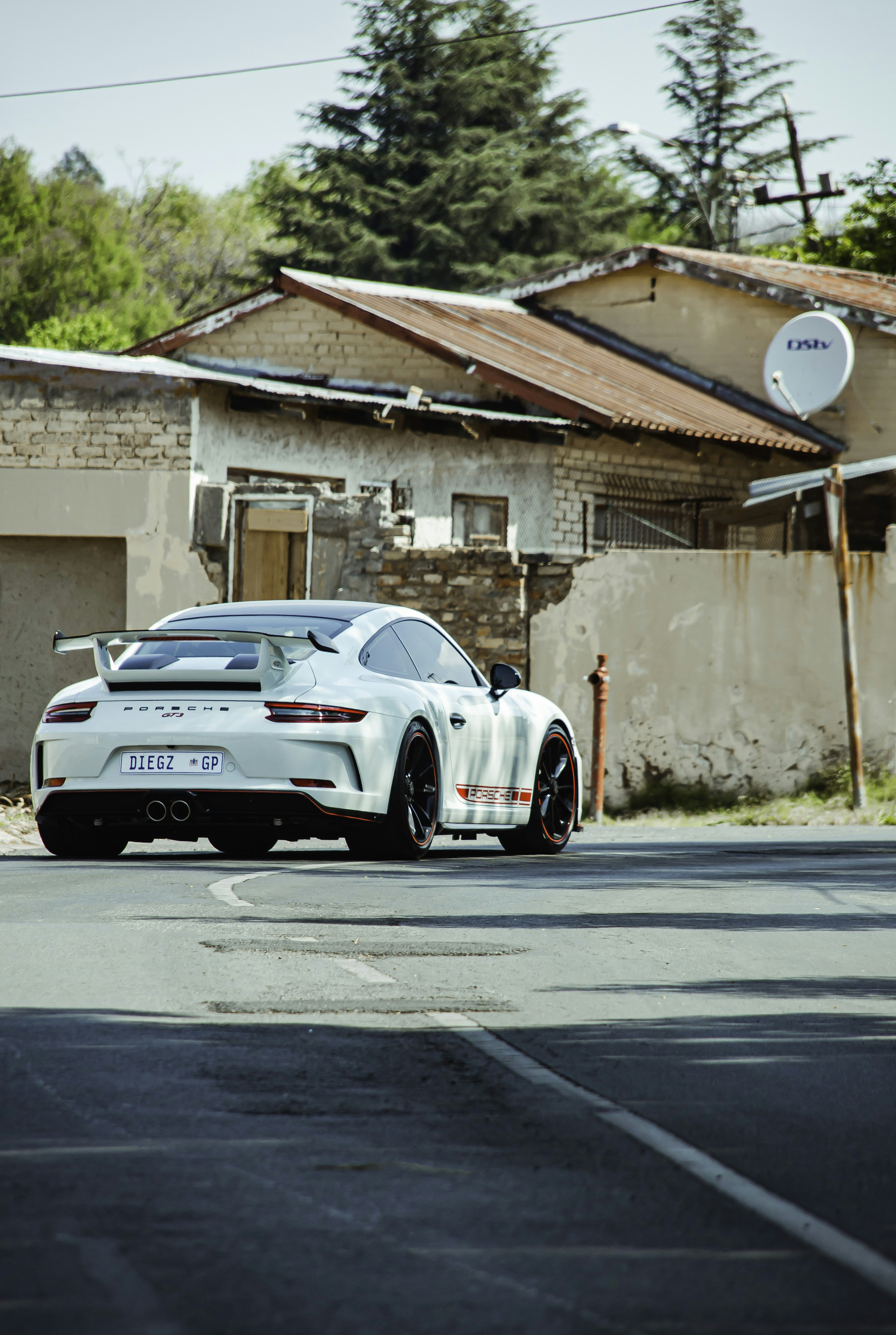 Rear-View Sprint: White Porsche on a Quiet Street