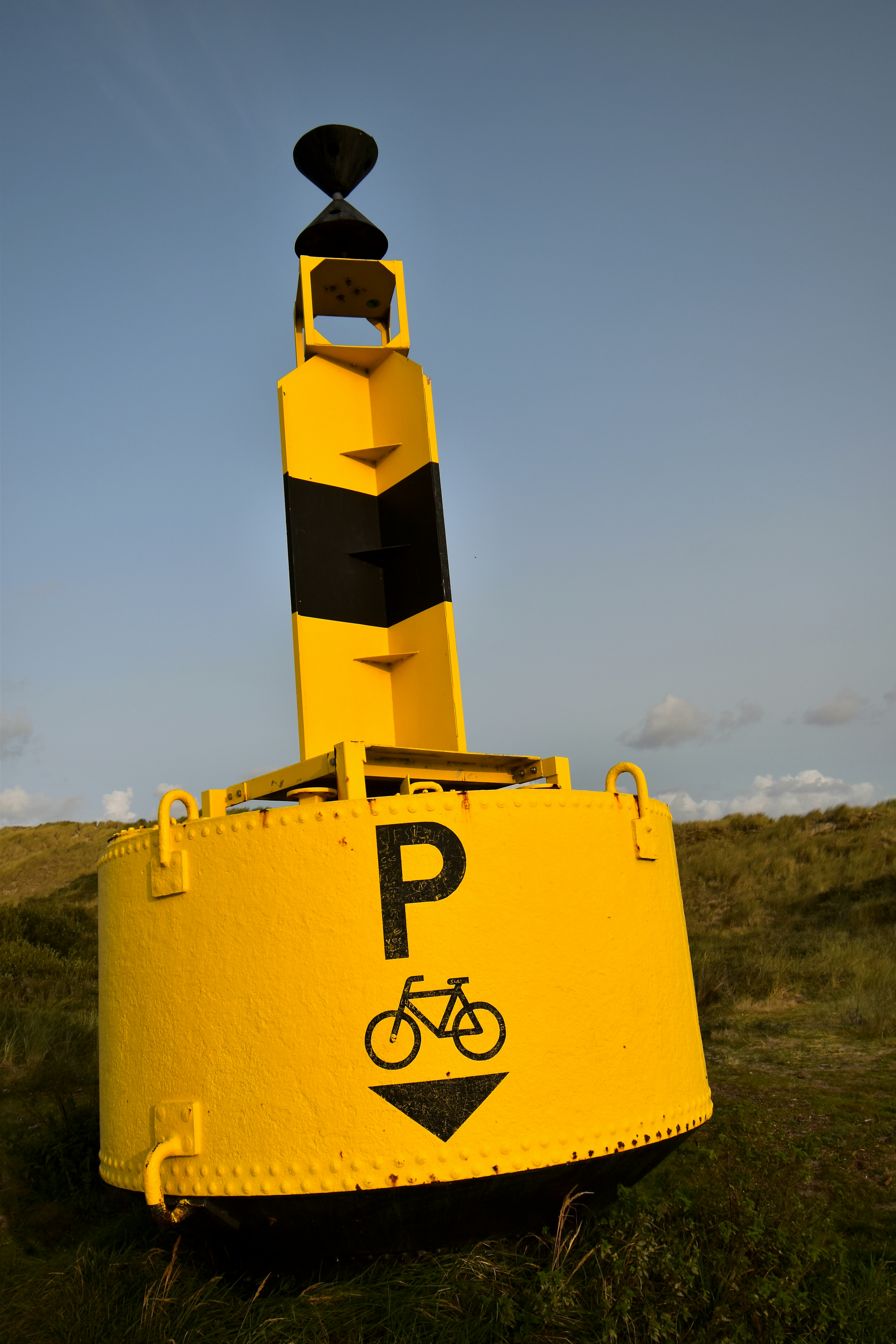 Yellow beacon on wheels: coastal buoy with a bike icon