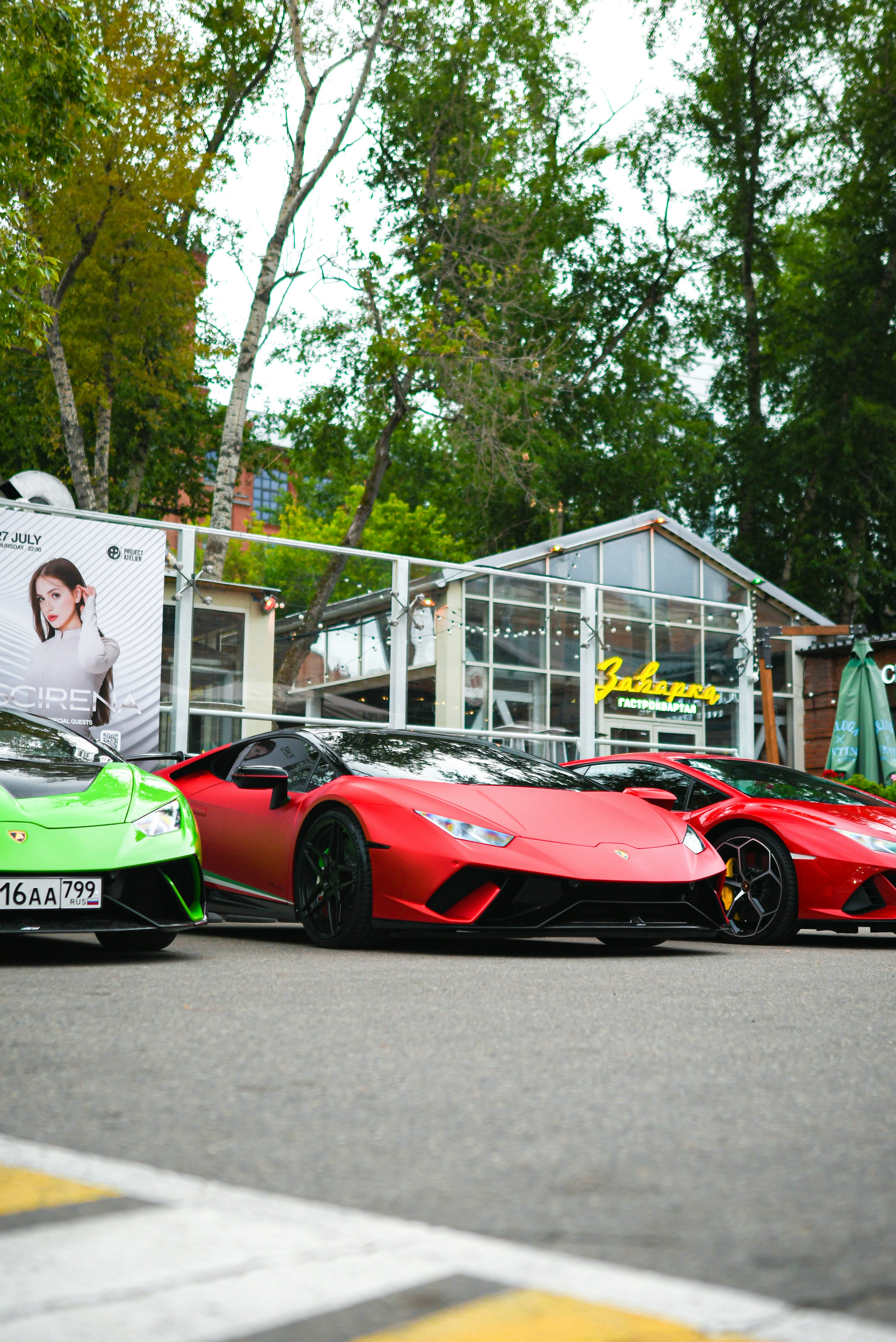 Crimson Lineup: A Trio of Italian Supercars at a Glass-Walled Showroom