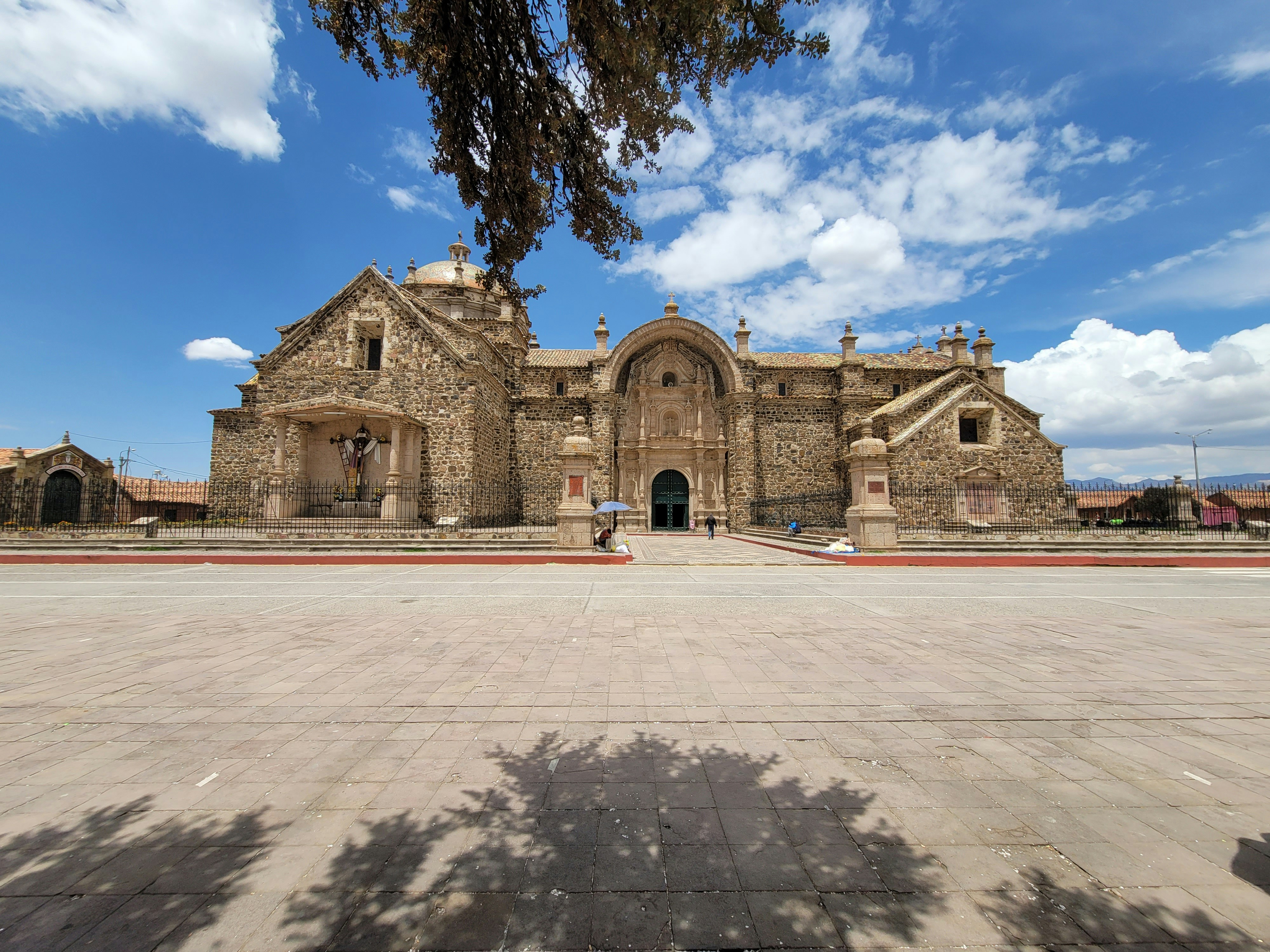 Gateway Under a Wide Sky: The Central Arch of a Historic Stone Church