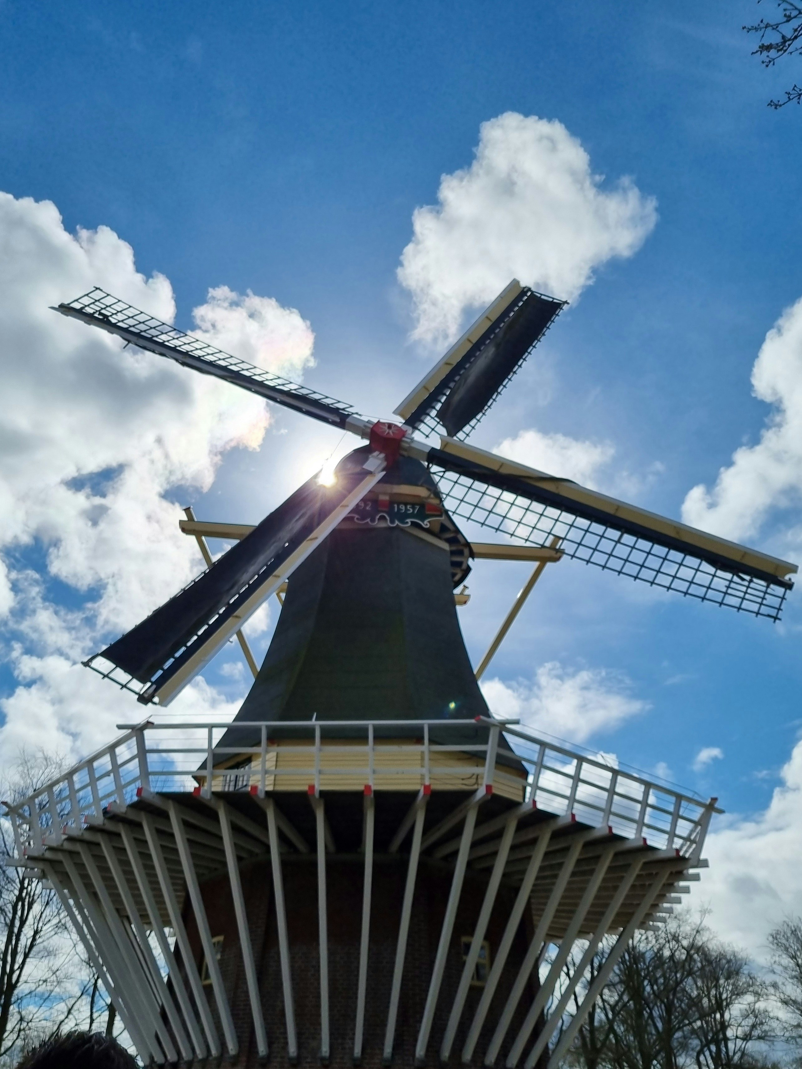 Sunflare at the Mill: Geometric Blades Reach for a Bright Sky