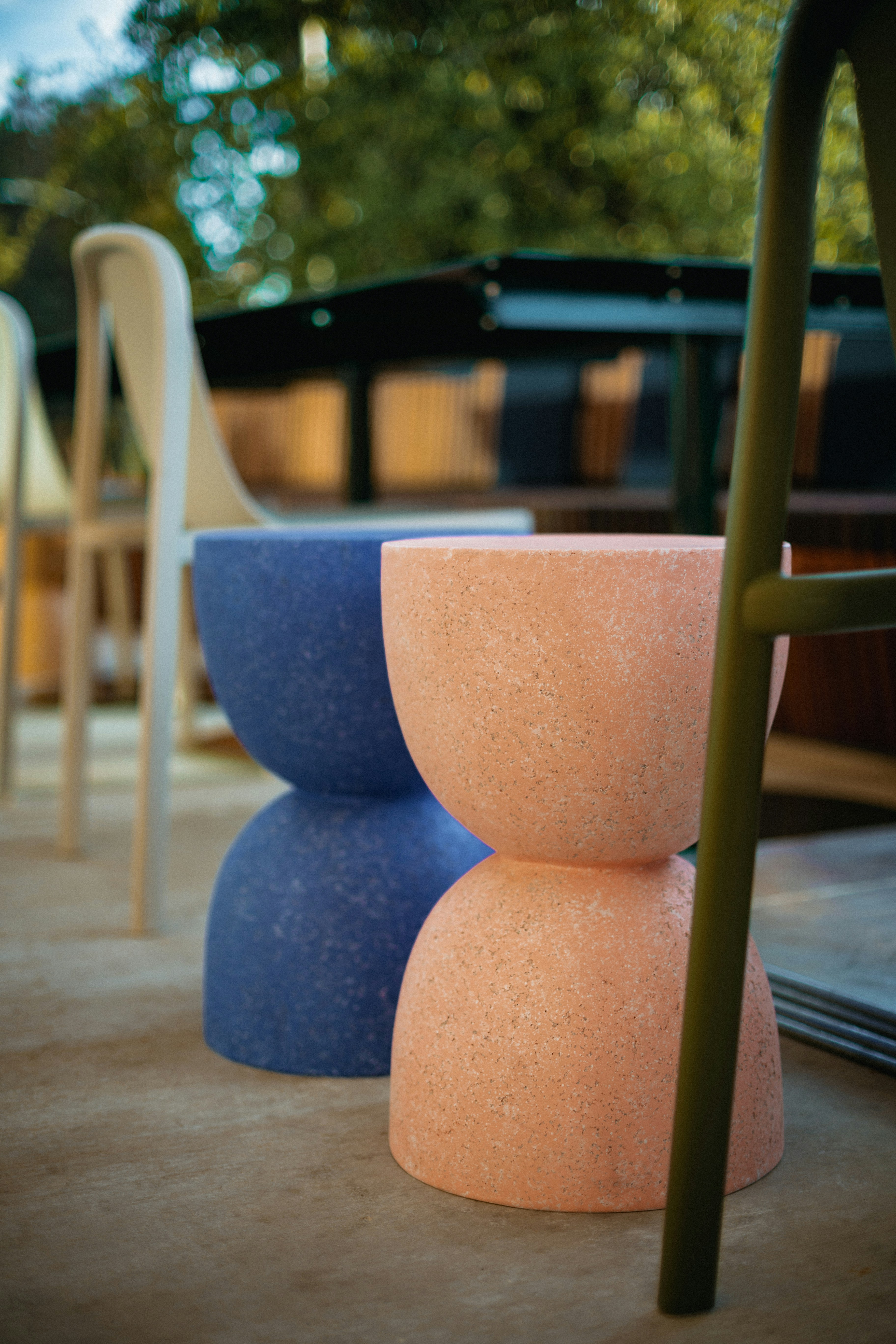 Stone hourglasses under café shade