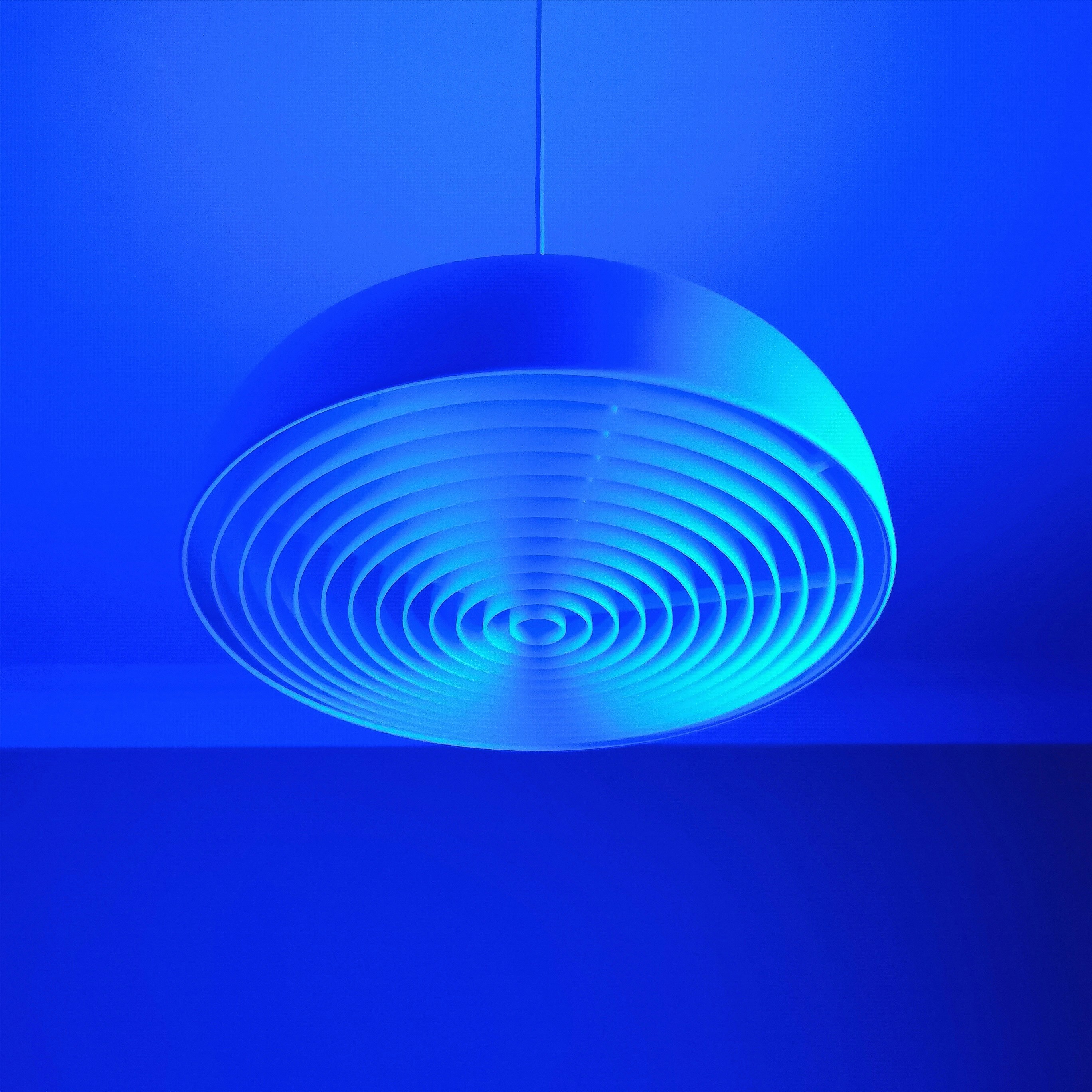A circular light fixture in a blue room photo – Free Blue Image on Unsplash