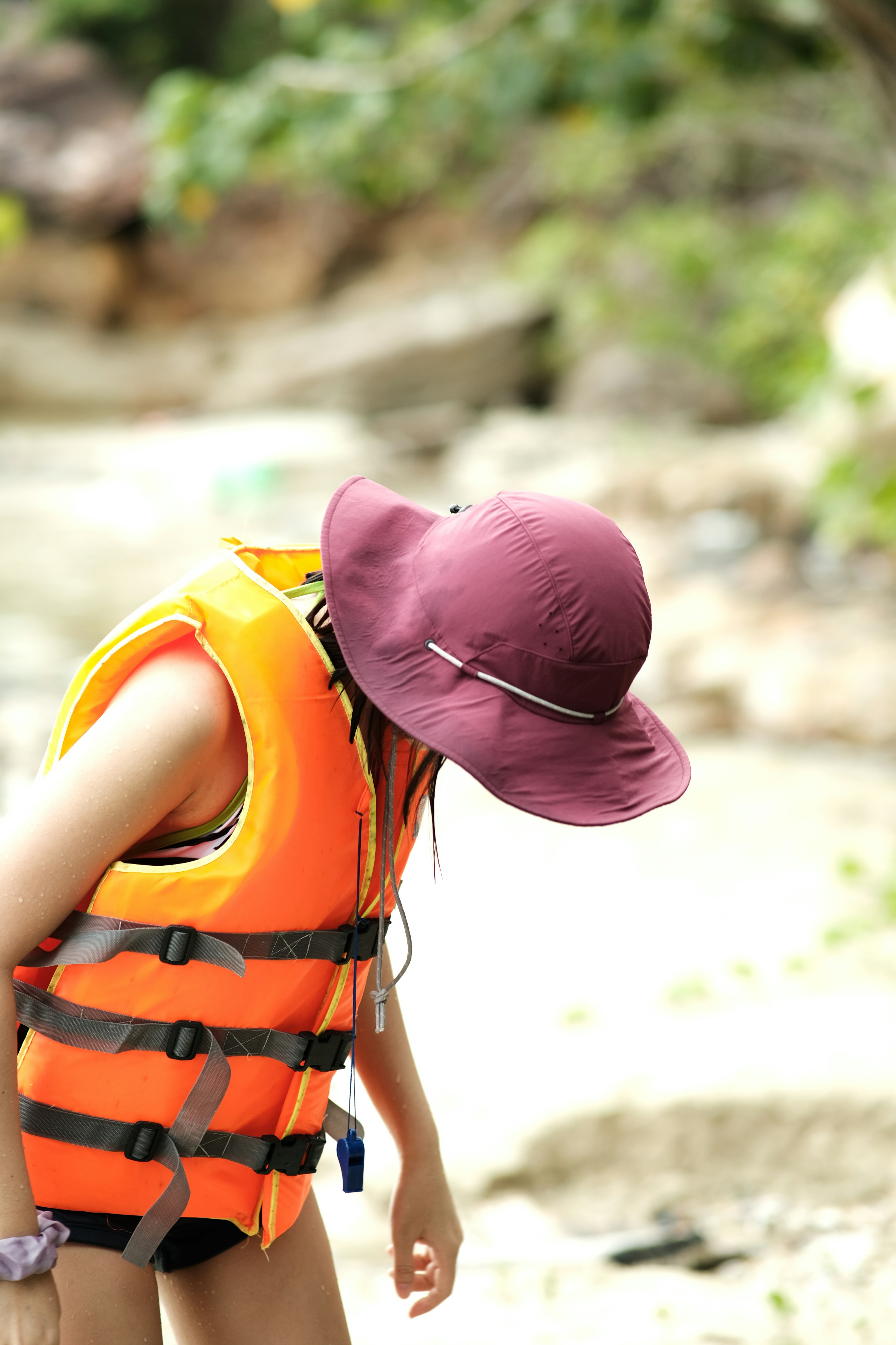 Youth at the Water's Edge: Life Jacket and Hat in Gentle Tilt
