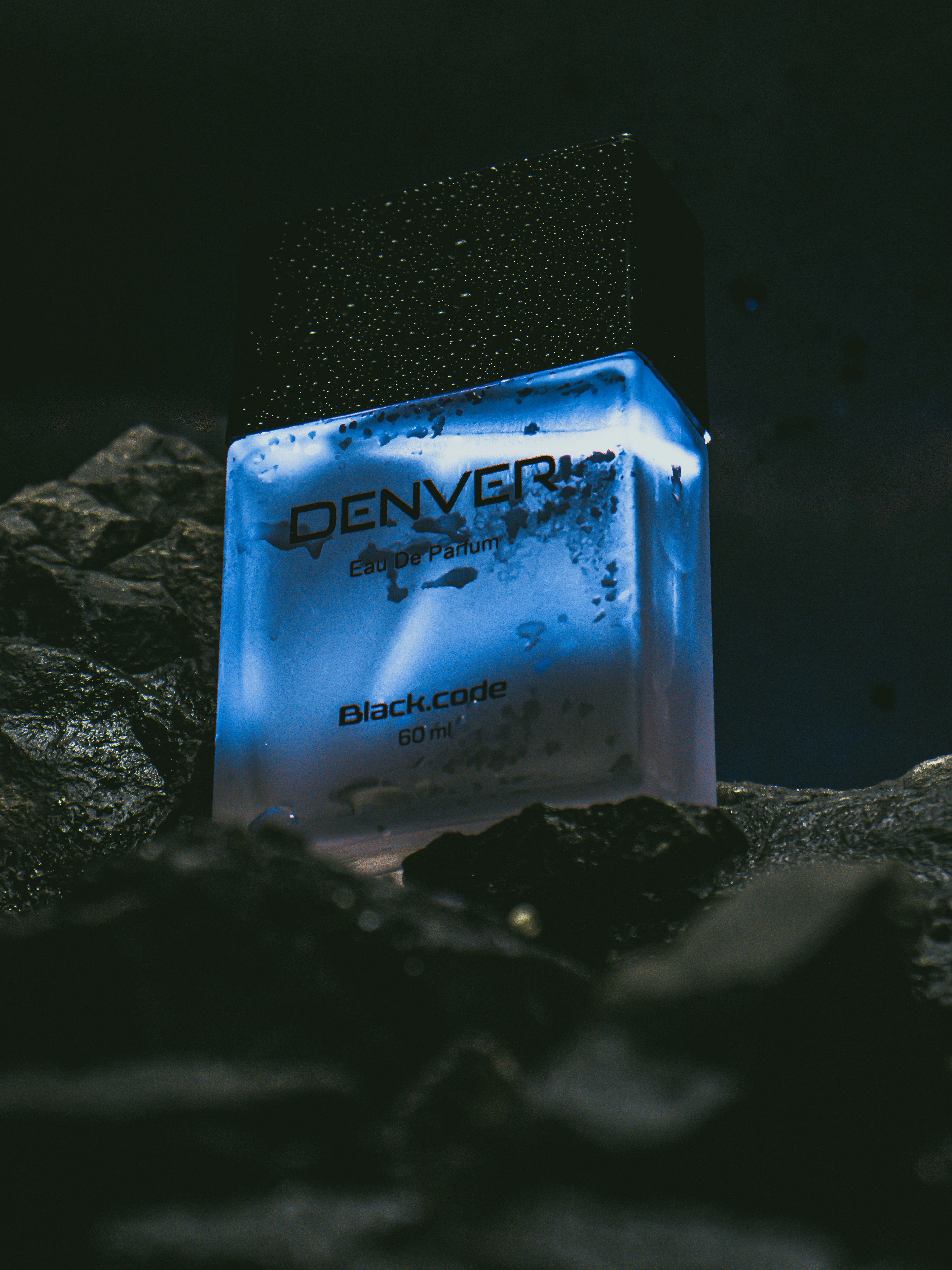 A bottle of denver cologne sitting on a rock photo – Free Beard oil ...