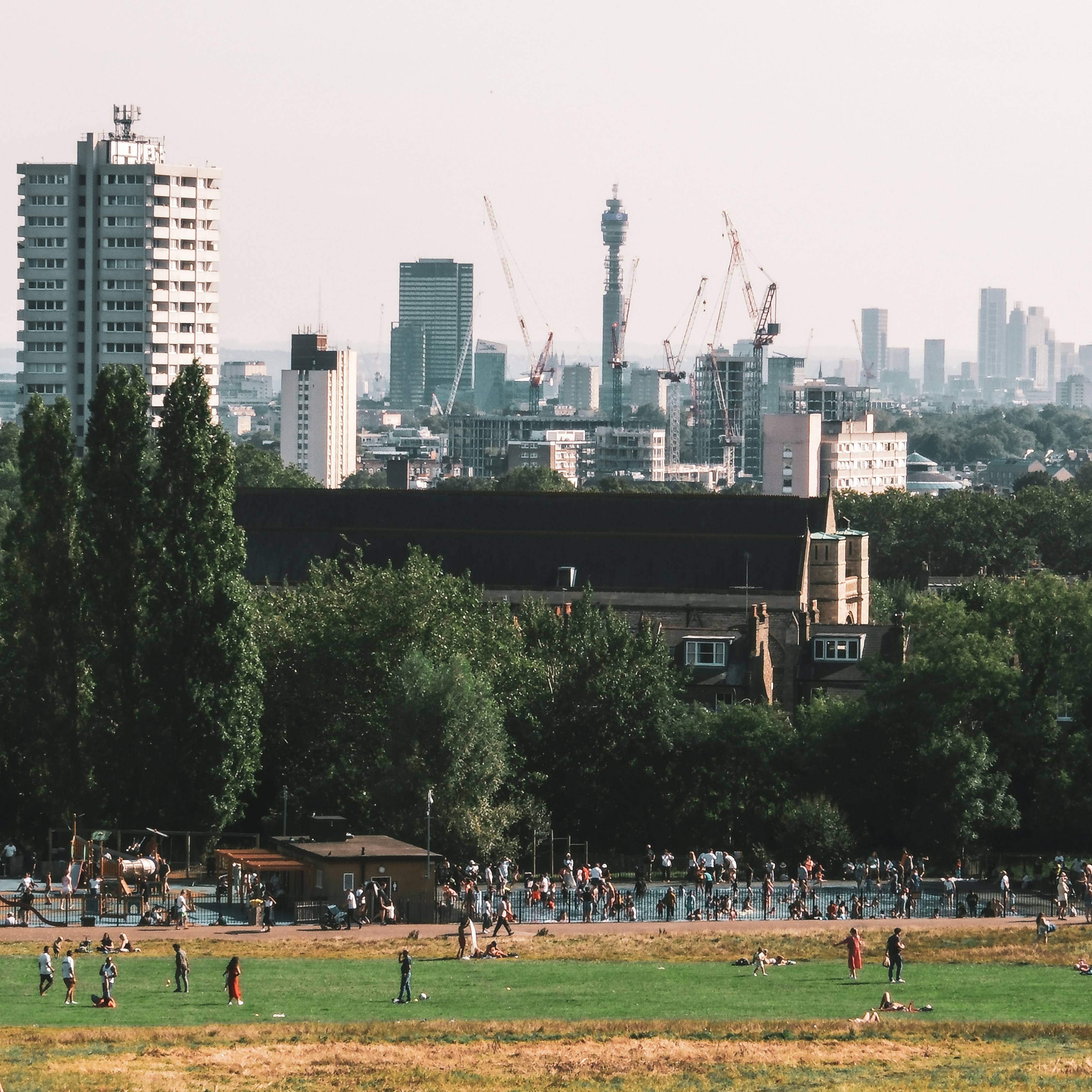 Cityscape Playground: A City Park Framed by Towers and Trees